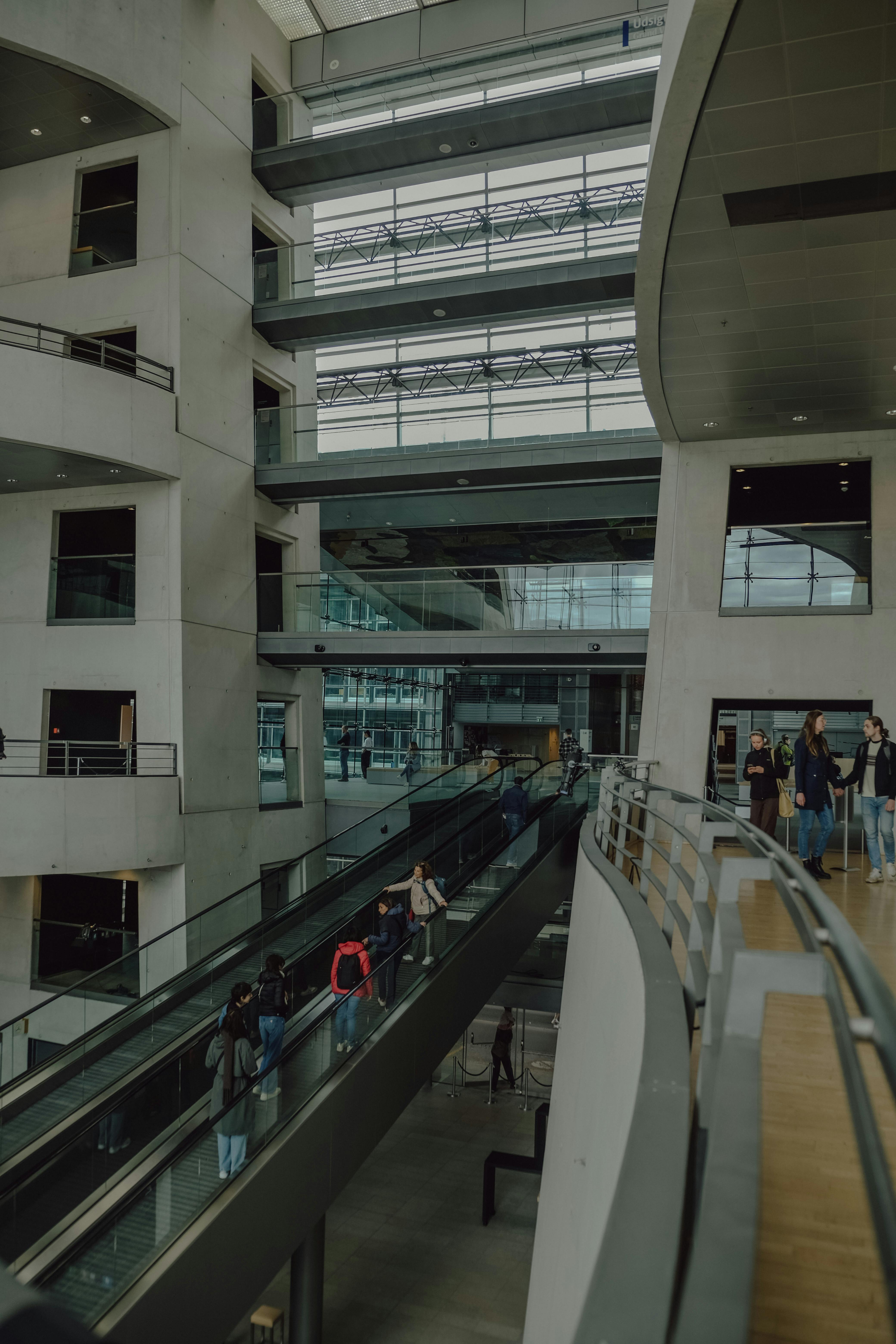 Modern Atrium with Escalators and People · Free Stock Photo