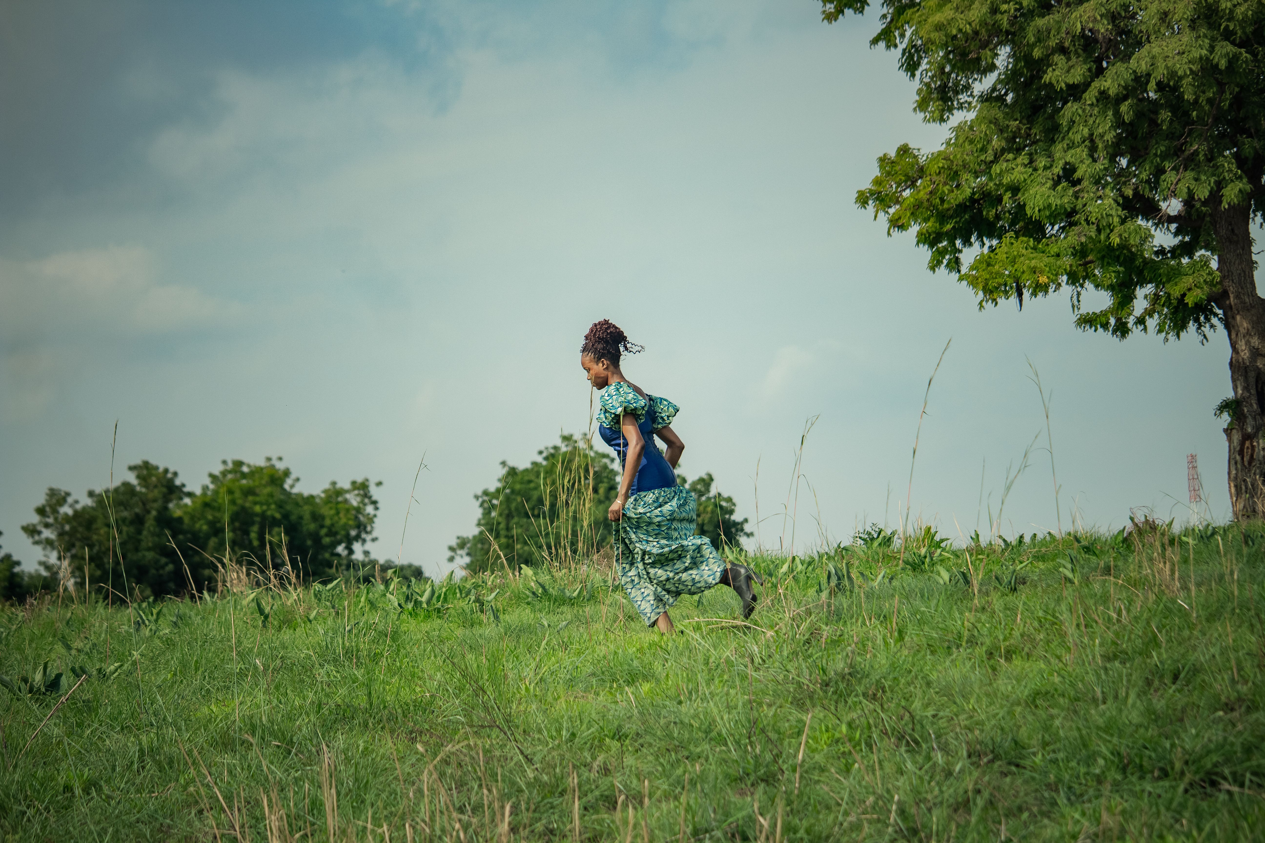 Woman Running Through Green Field Outdoors · Free Stock Photo