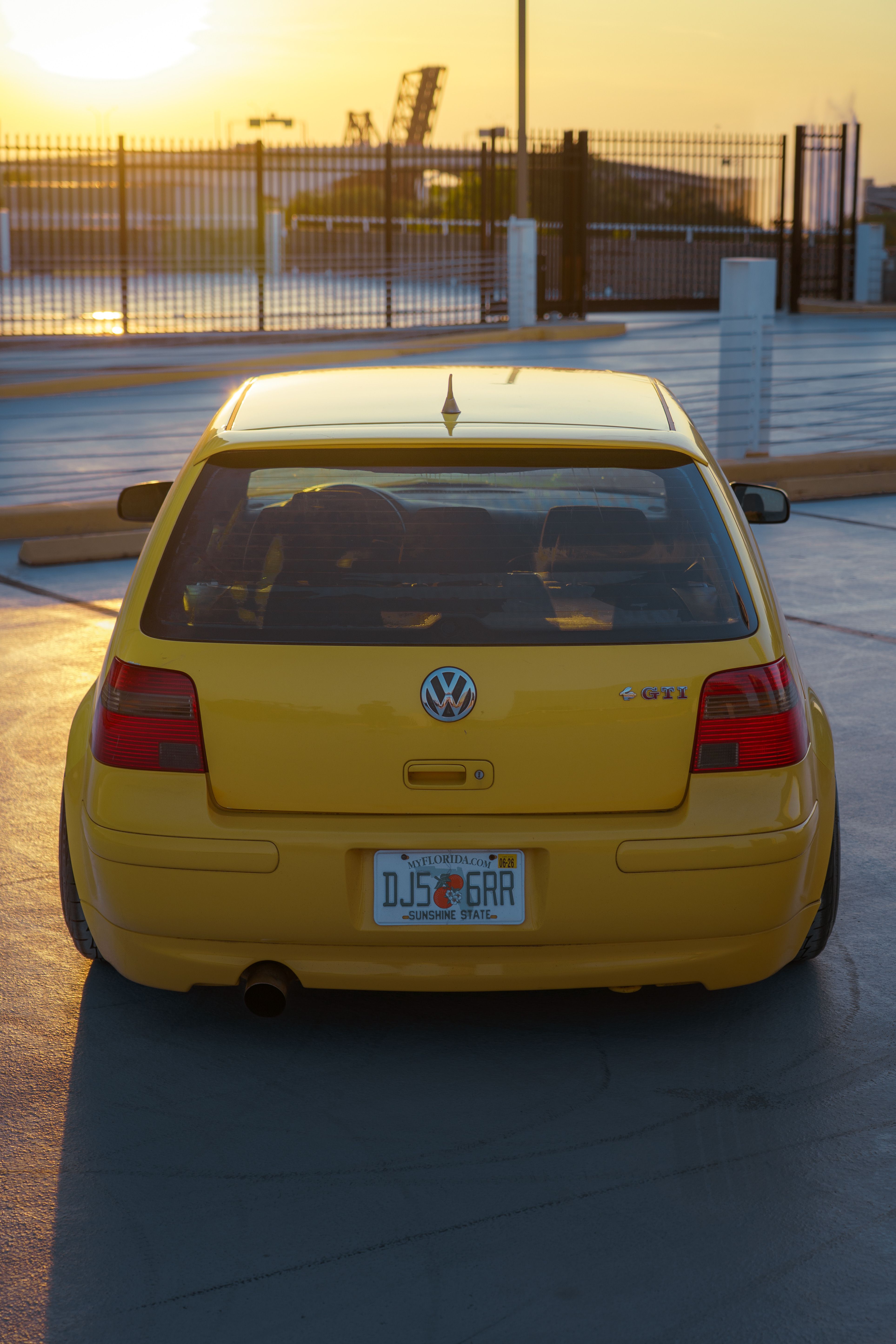 Yellow Volkswagen Golf GTI at Sunset in Urban Setting · Free Stock Photo