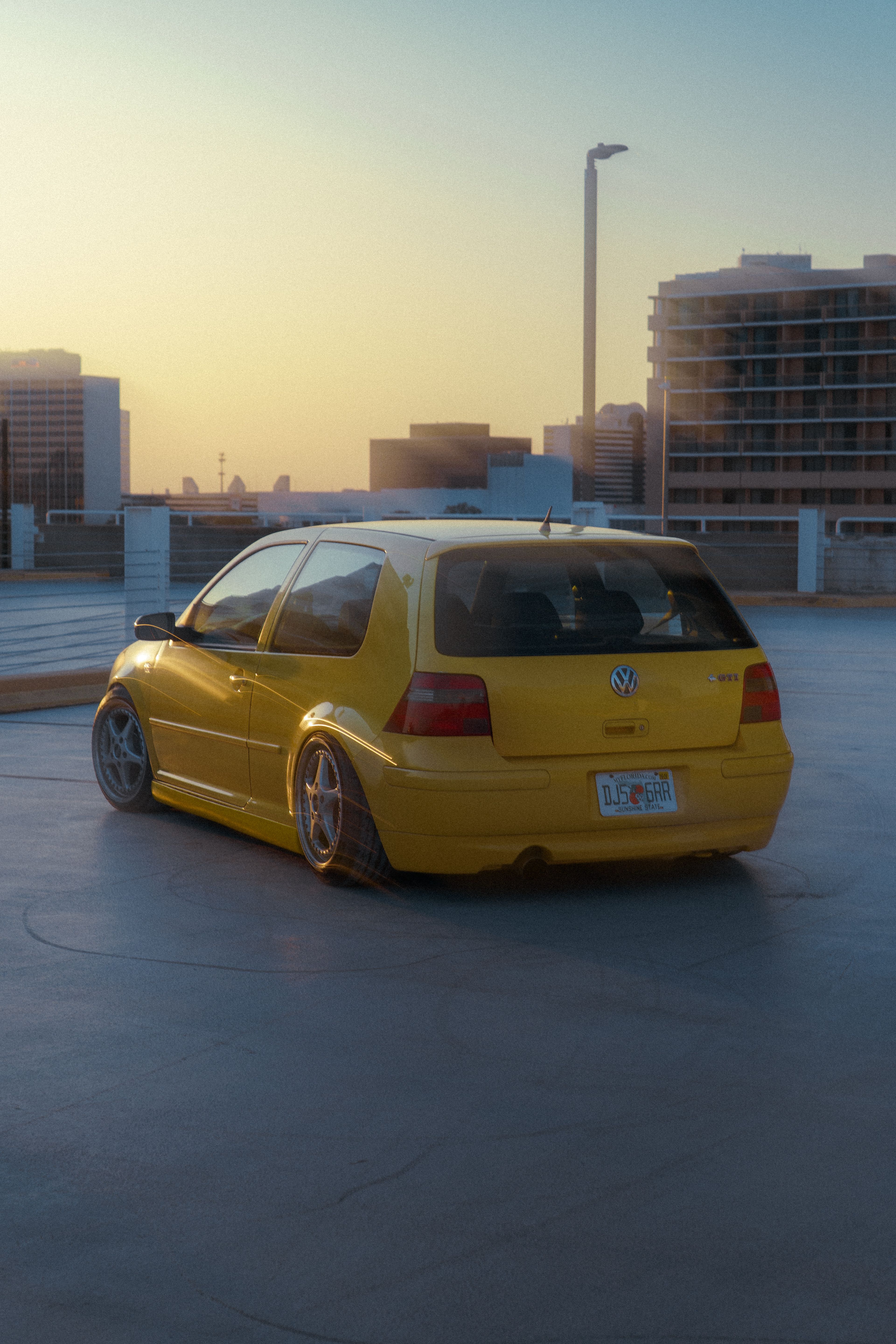 Yellow Car Parked on Urban Rooftop at Sunset · Free Stock Photo