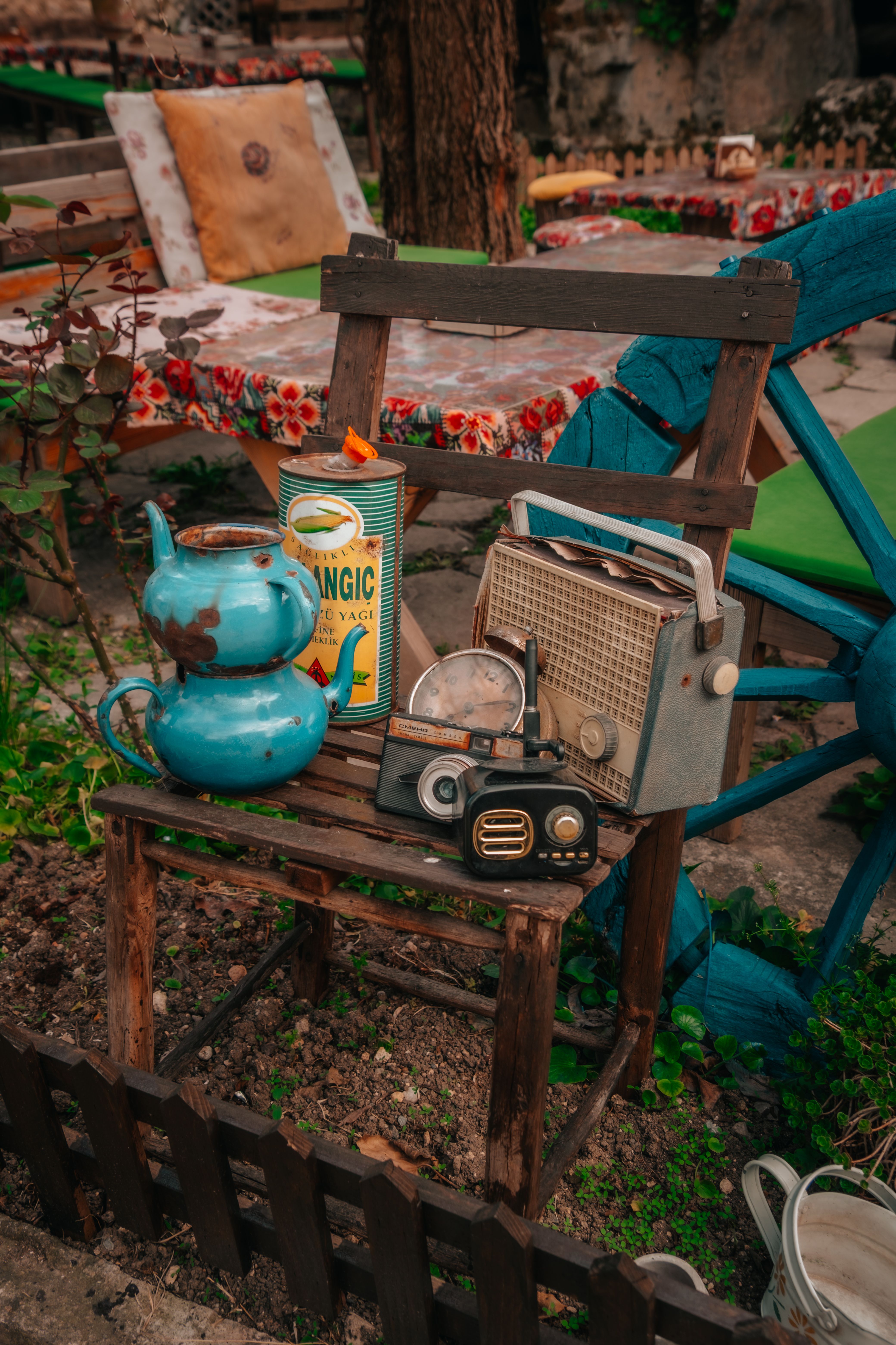Vintage Items on Rustic Chair Outdoors · Free Stock Photo