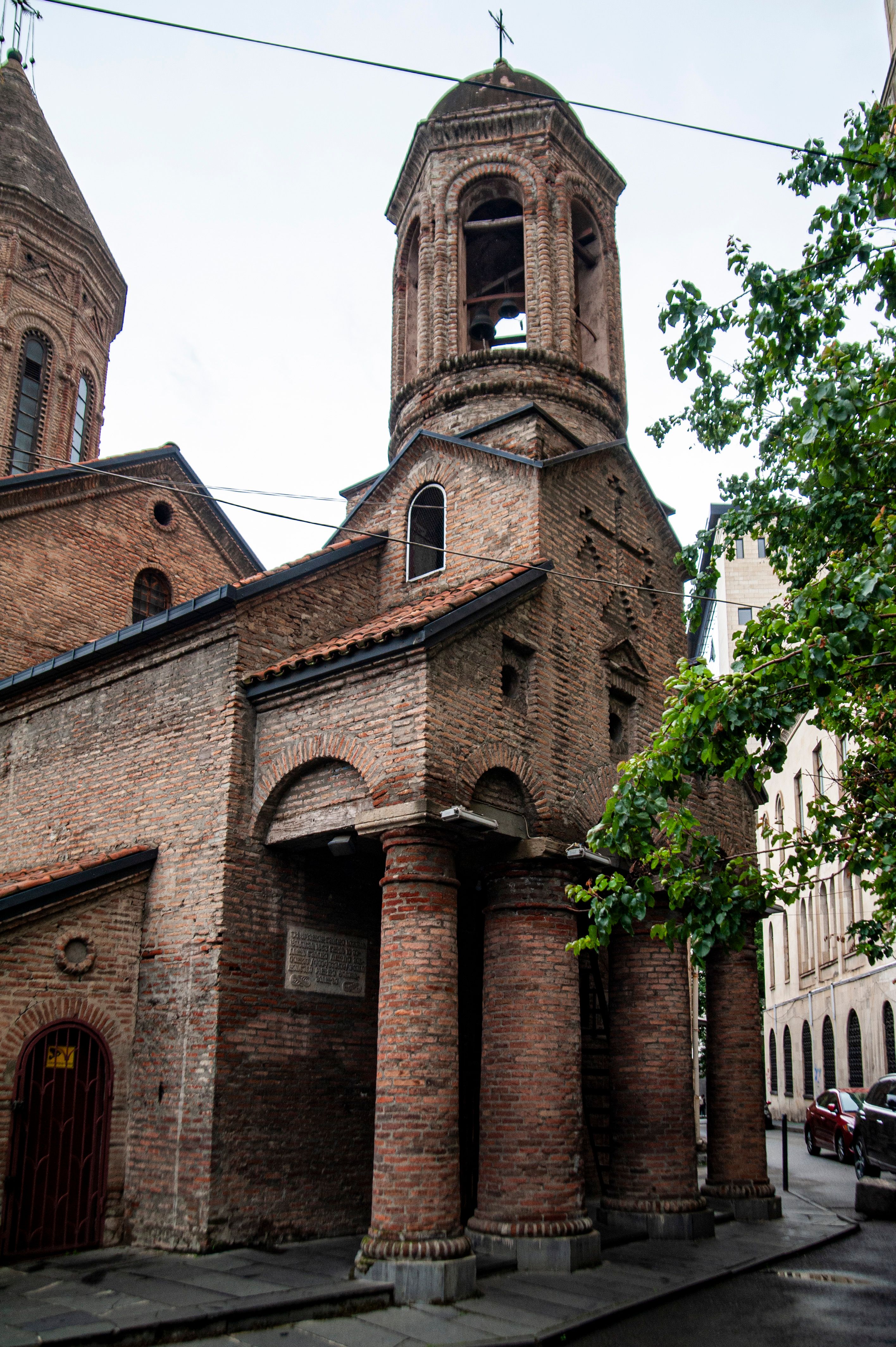 Historic Brick Church with Tower in Urban Setting · Free Stock Photo