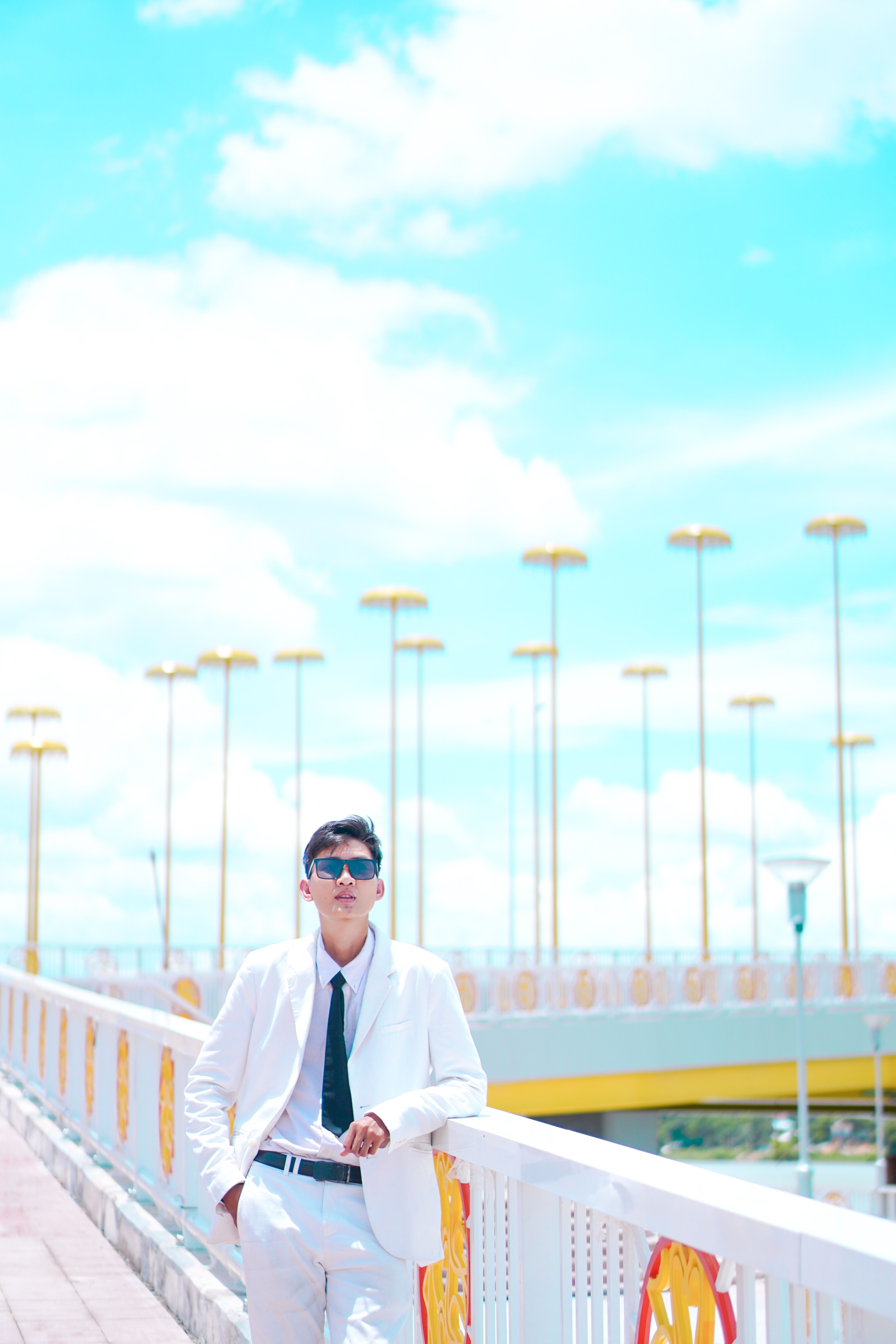 Stylish Man in White Suit on Modern Bridge · Free Stock Photo