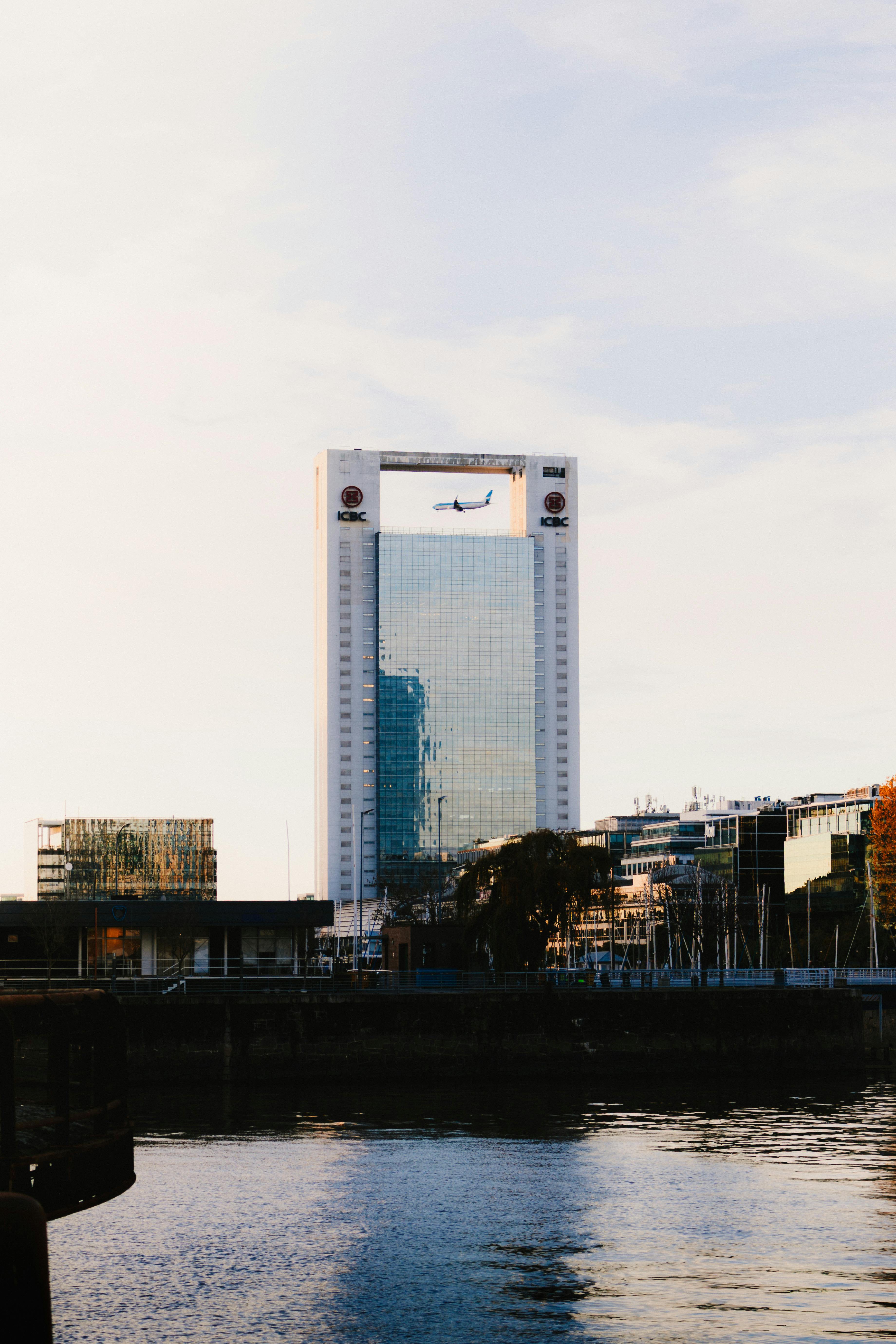 Airplane Framed by Unique Building in Buenos Aires · Free Stock Photo