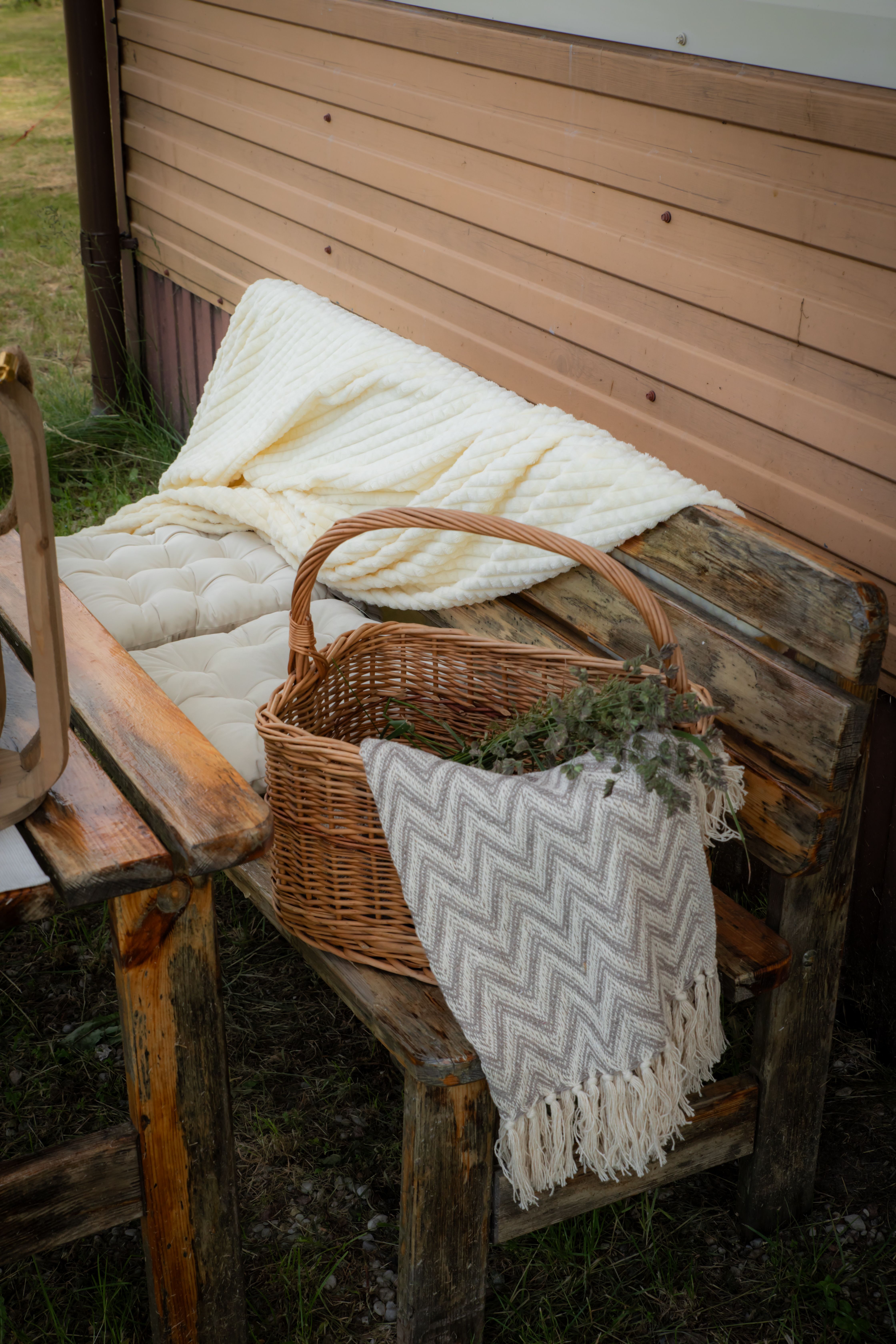 Cozy Rustic Outdoor Bench with Blanket and Basket · Free Stock Photo