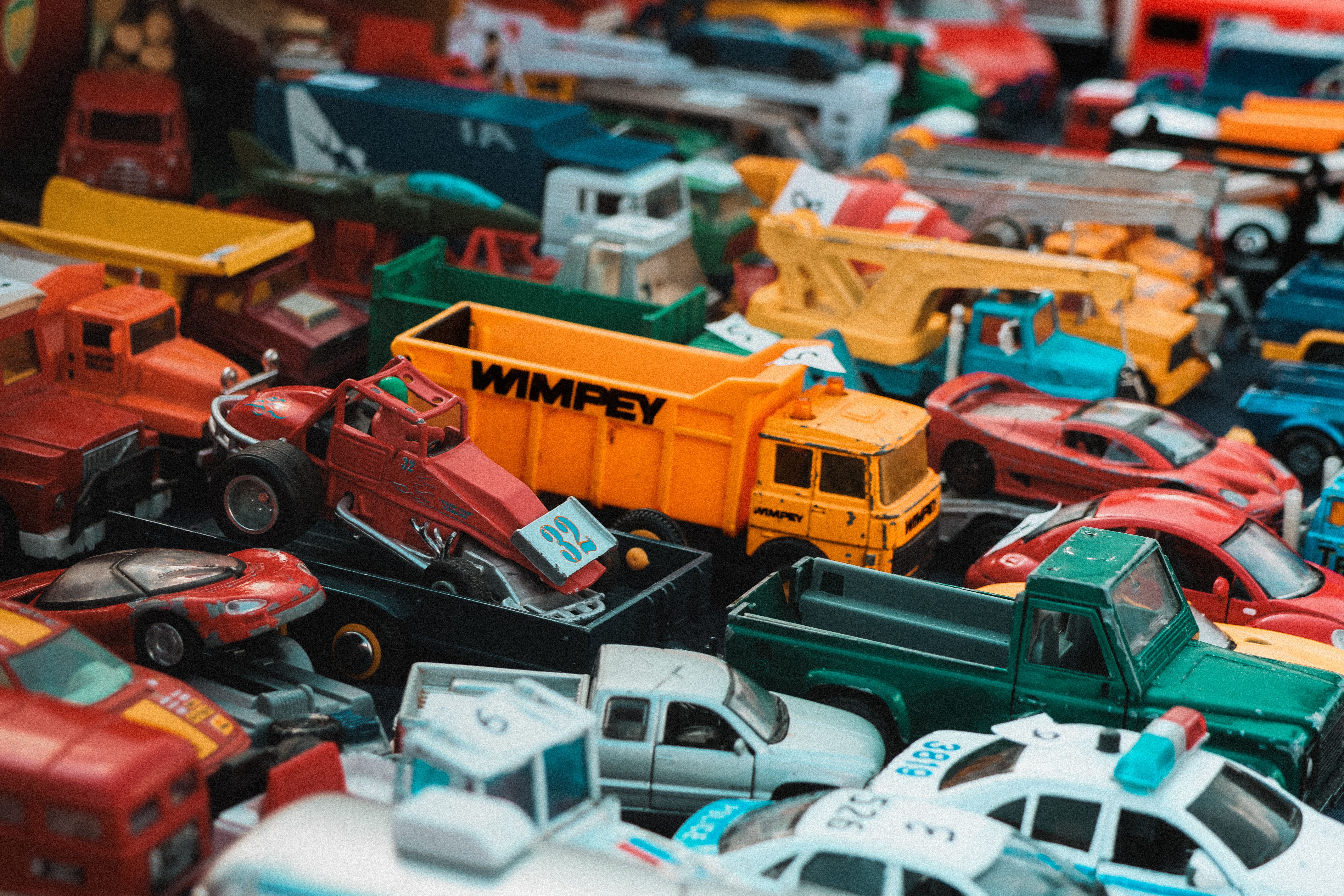 Colorful Collection of Vintage Toy Cars in Marketplace · Free Stock Photo