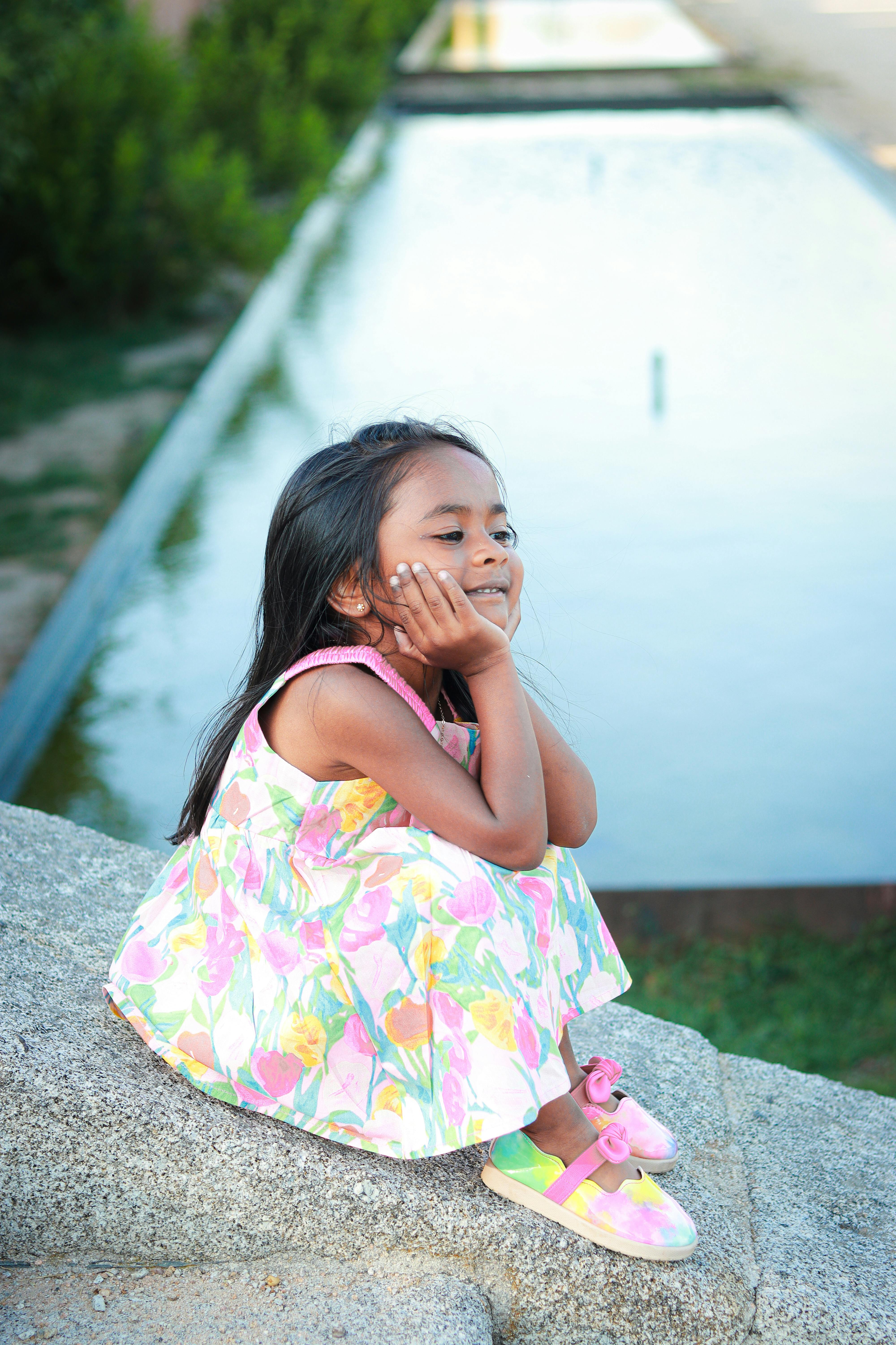 Smiling Girl by Reflective Water Channel Outdoors · Free Stock Photo