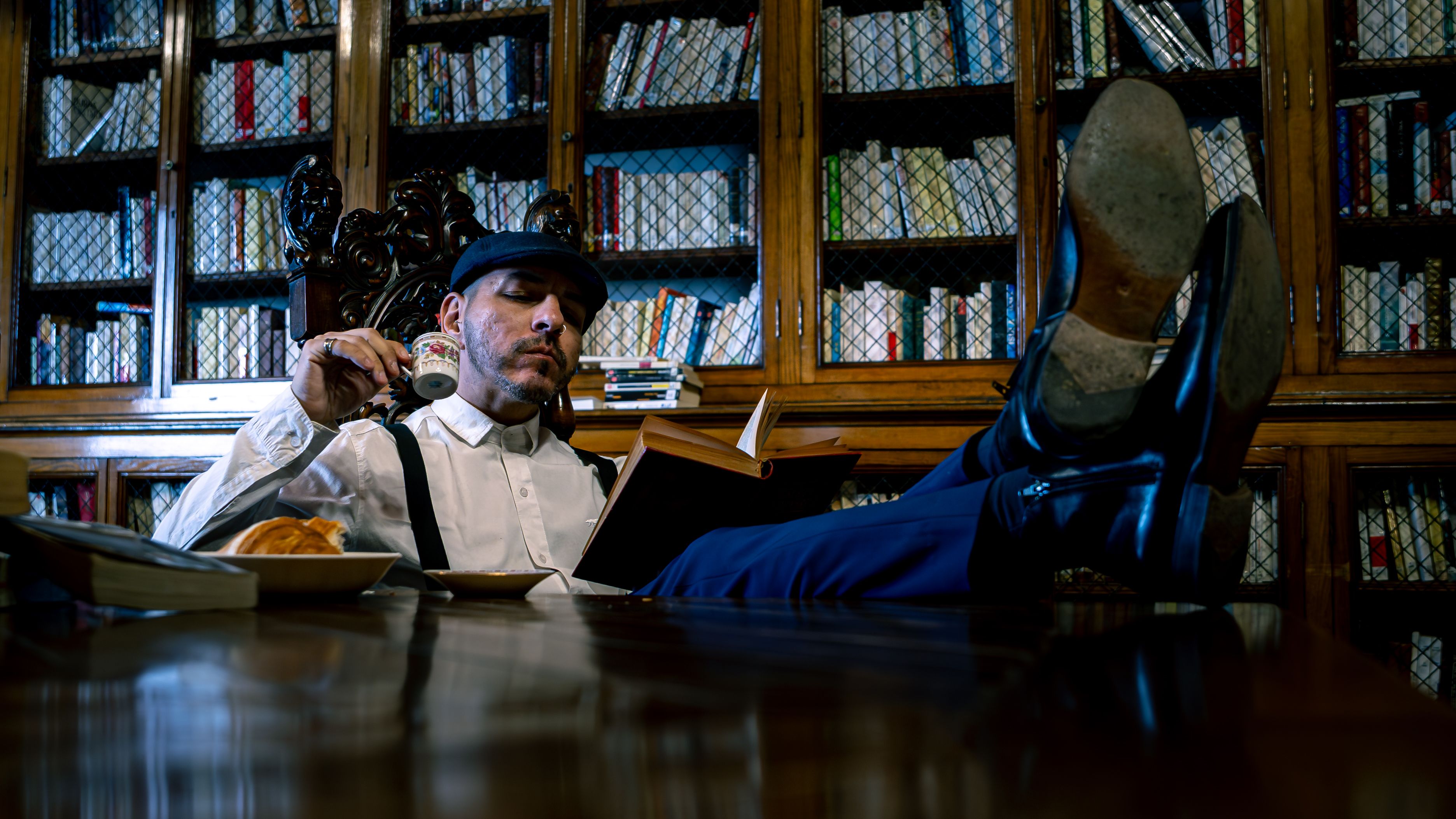 Relaxed Man Reading in Elegant Library Setting · Free Stock Photo