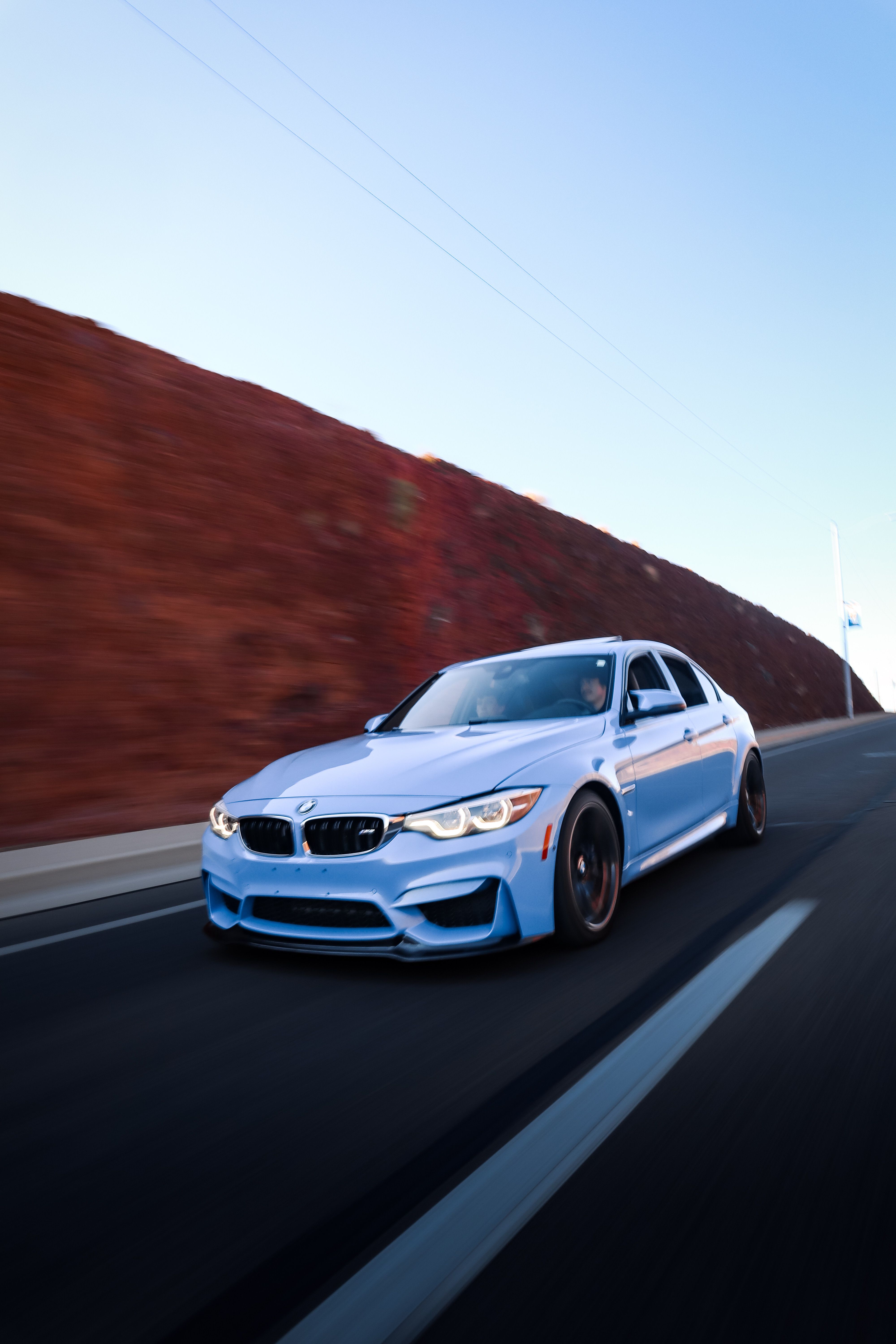 Dynamic Blue Car on Scenic Highway Drive · Free Stock Photo