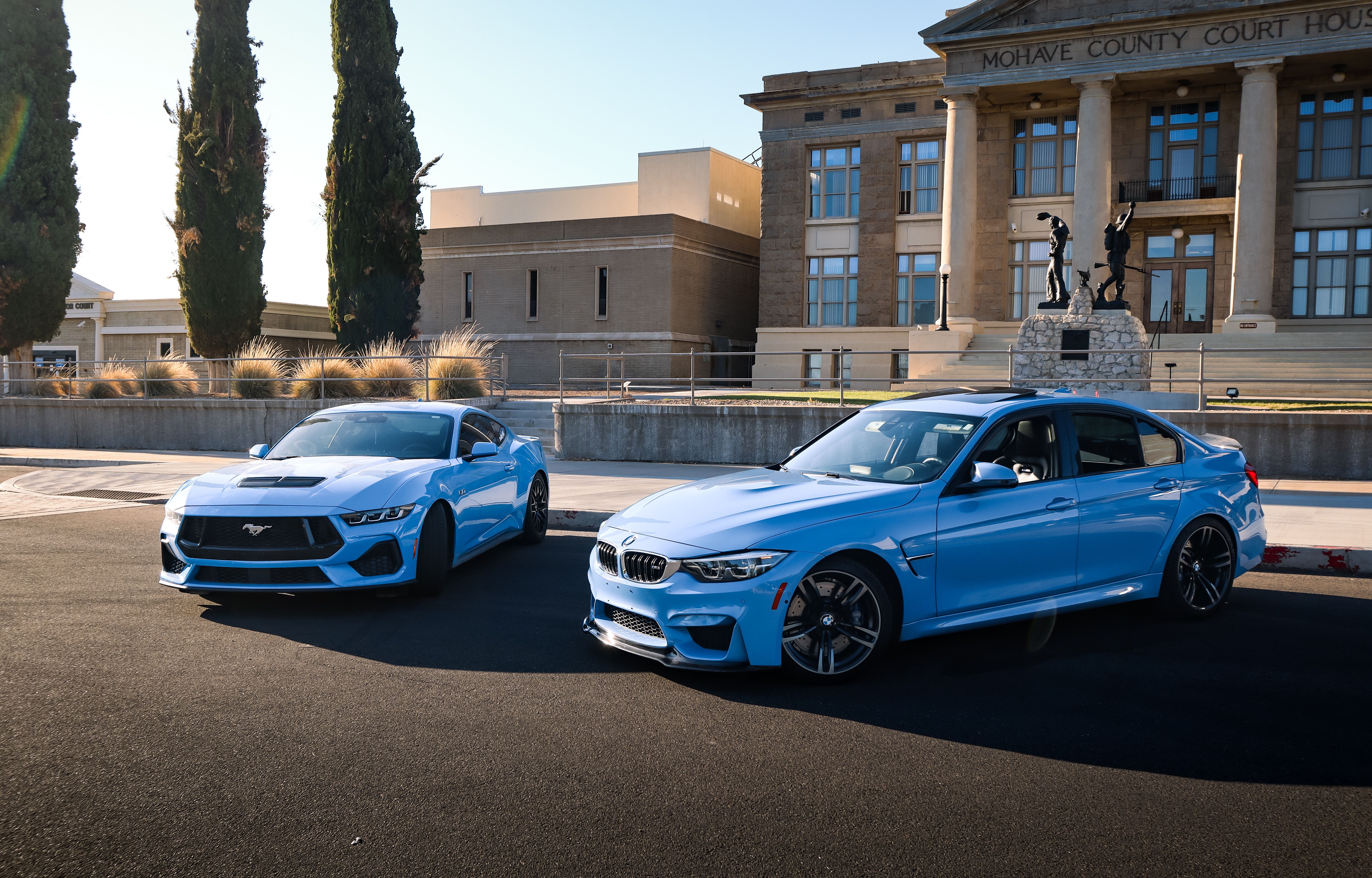 Elegant Blue Sports Cars in Front of Courthouse · Free Stock Photo