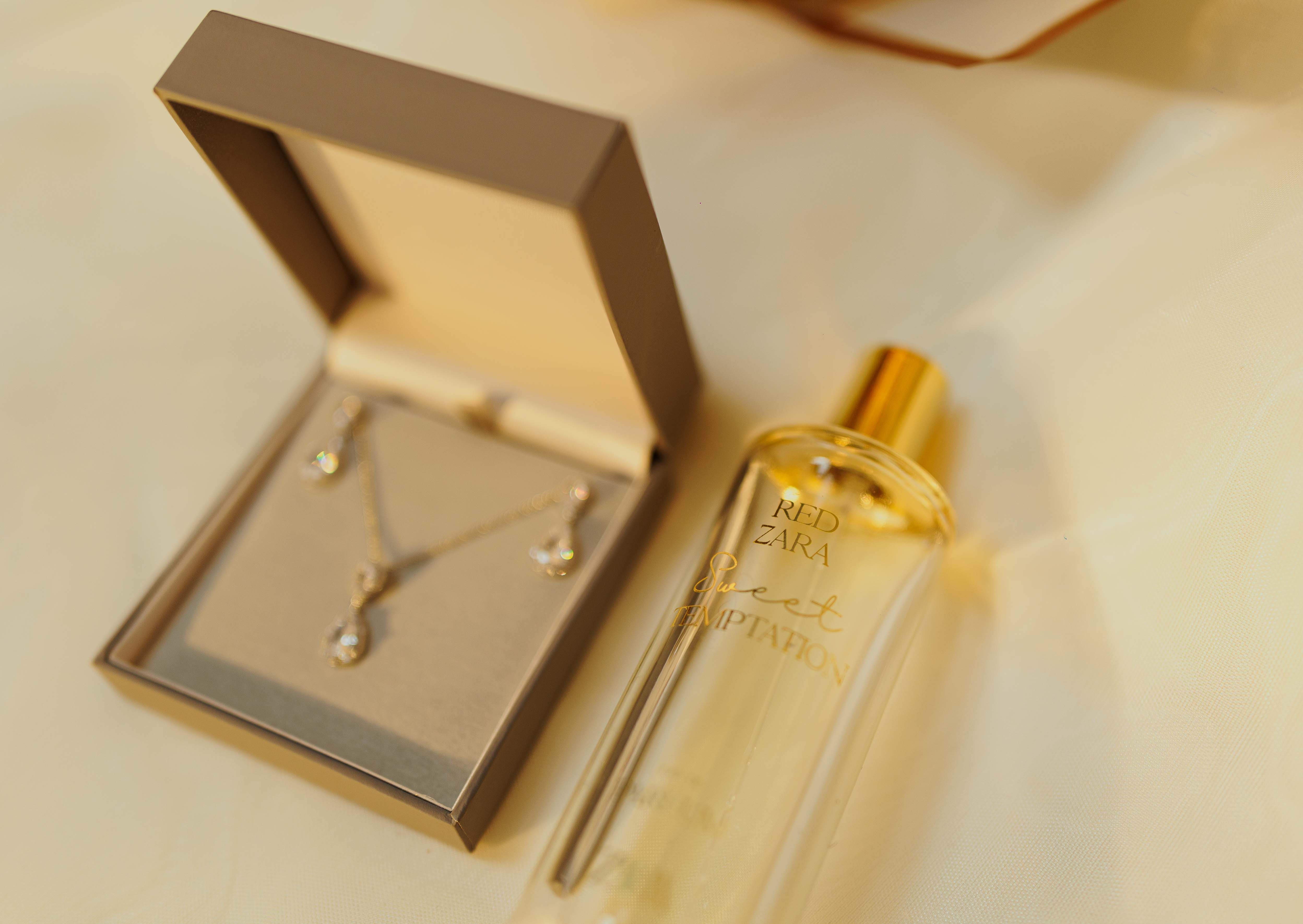 Elegant Jewelry and Perfume Flat Lay on Satin · Free Stock Photo