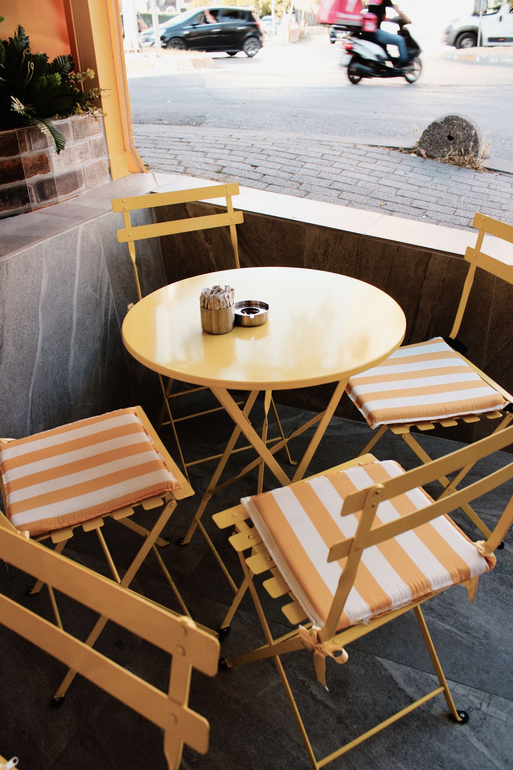 Cozy Outdoor Café Seating with Yellow Furniture · Free Stock Photo