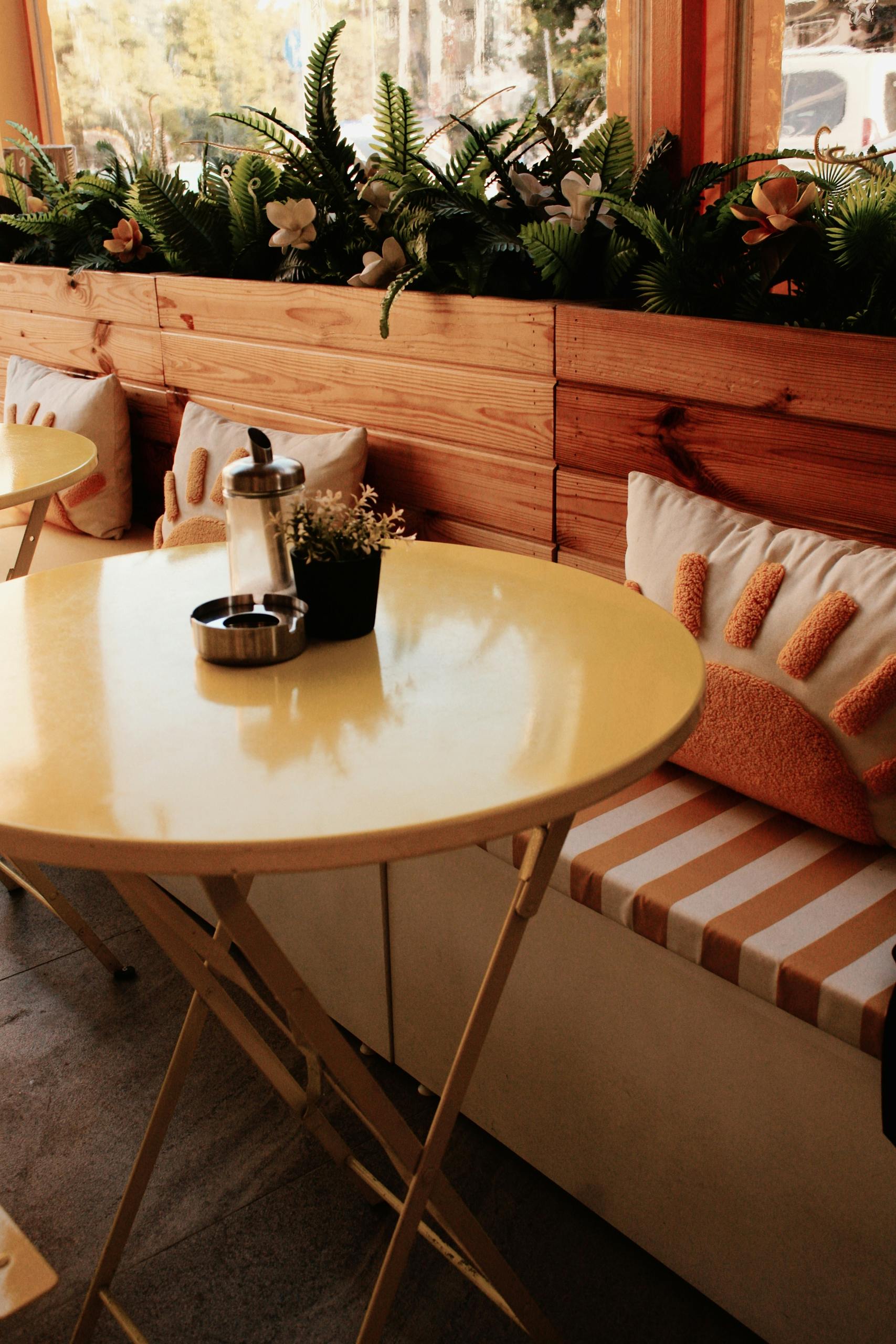 Cozy Outdoor Cafe Setting with Plants · Free Stock Photo