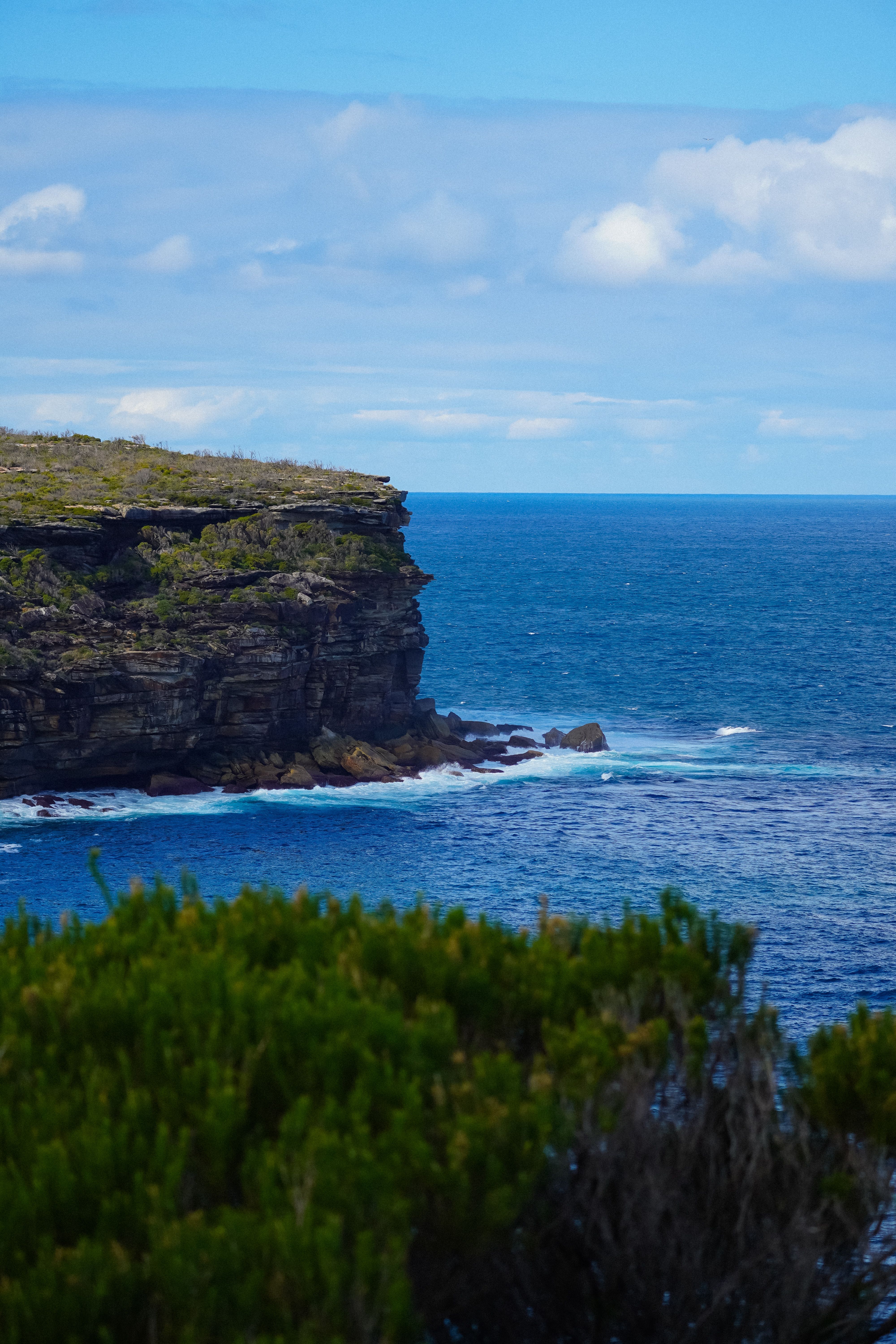 Scenic Coastal Cliff Overlooking Ocean Waves · Free Stock Photo