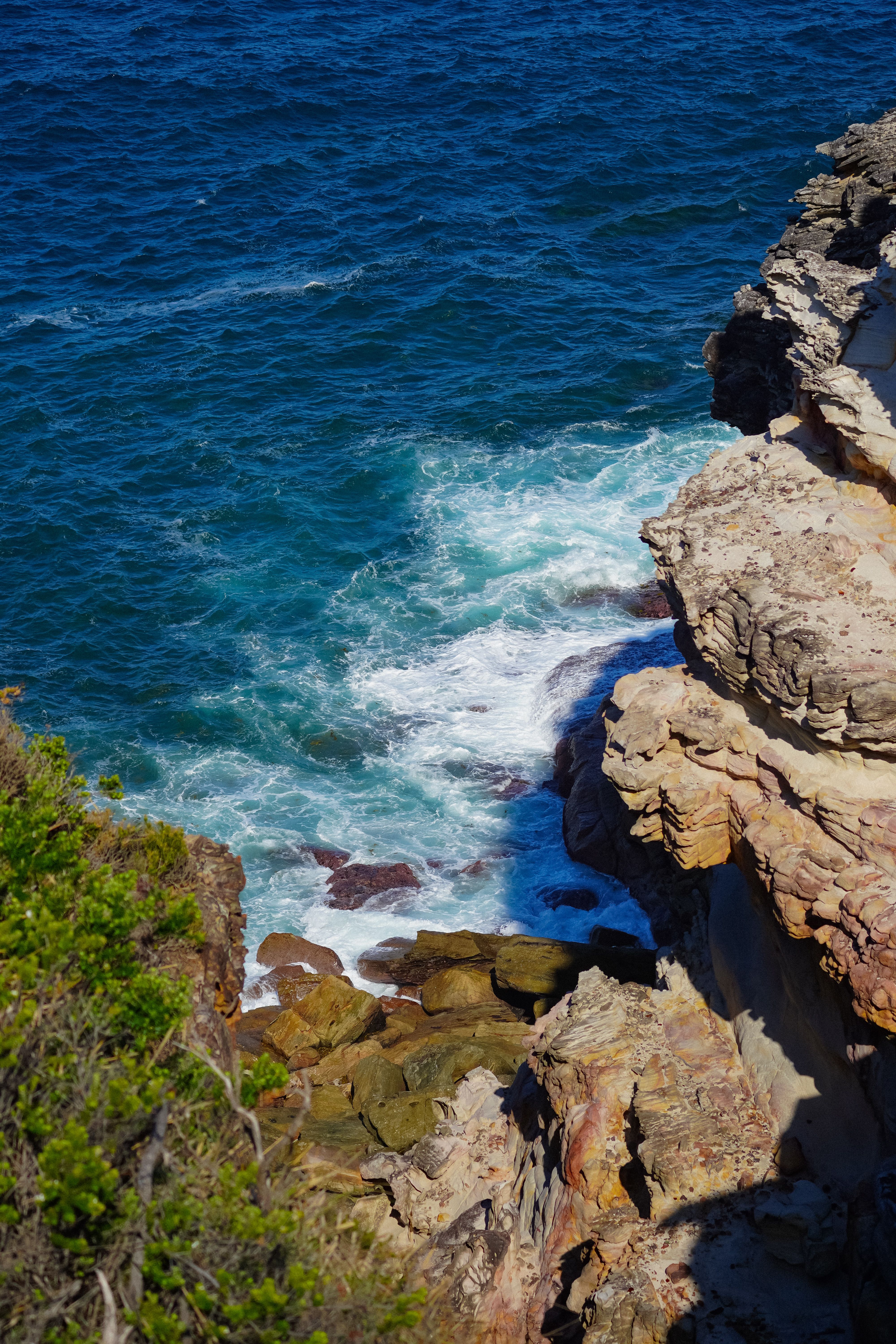 Dramatic Coastal Cliff Overlooking Ocean Waves · Free Stock Photo