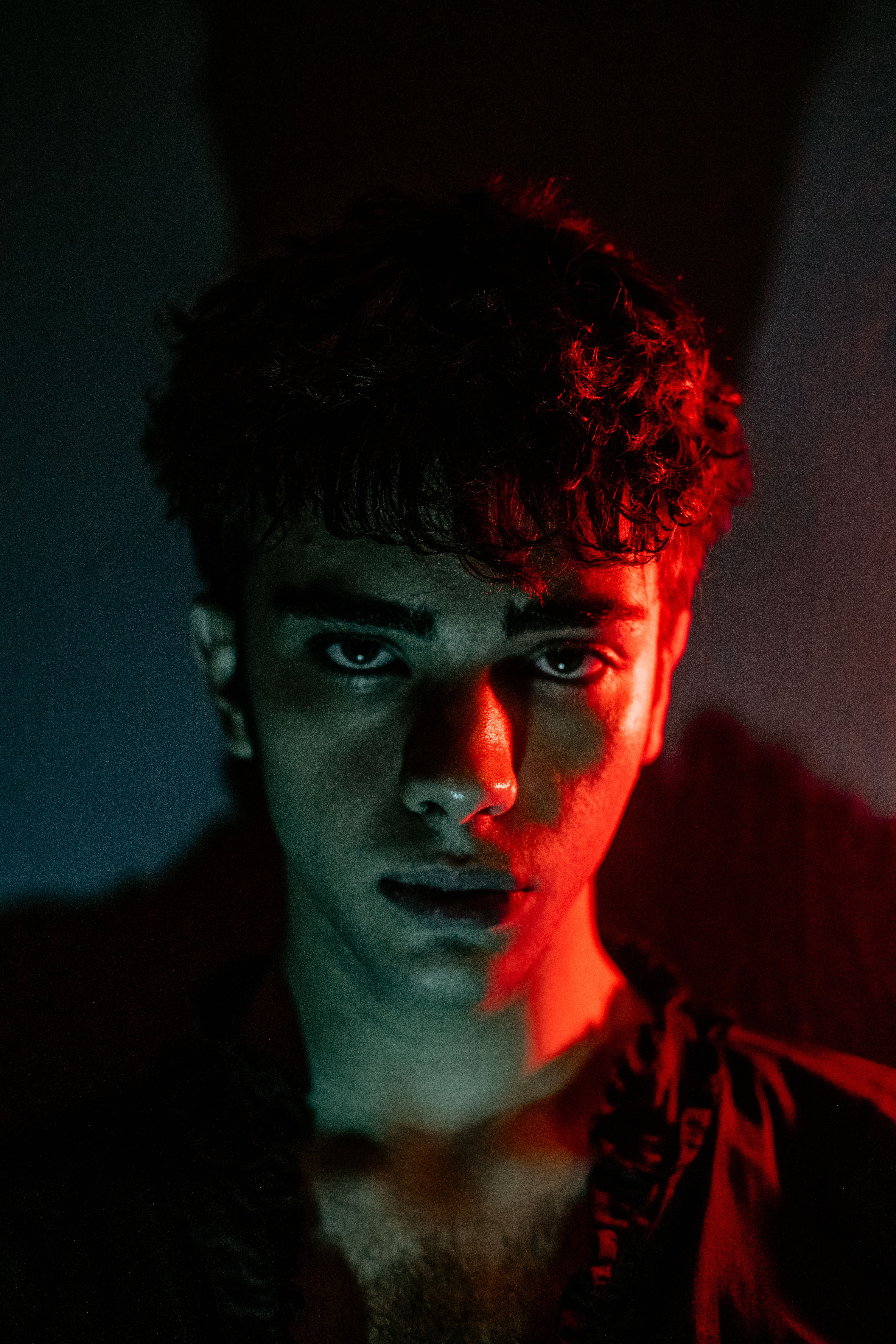 Dramatic Portrait of a Young Man with Red Lighting · Free Stock Photo
