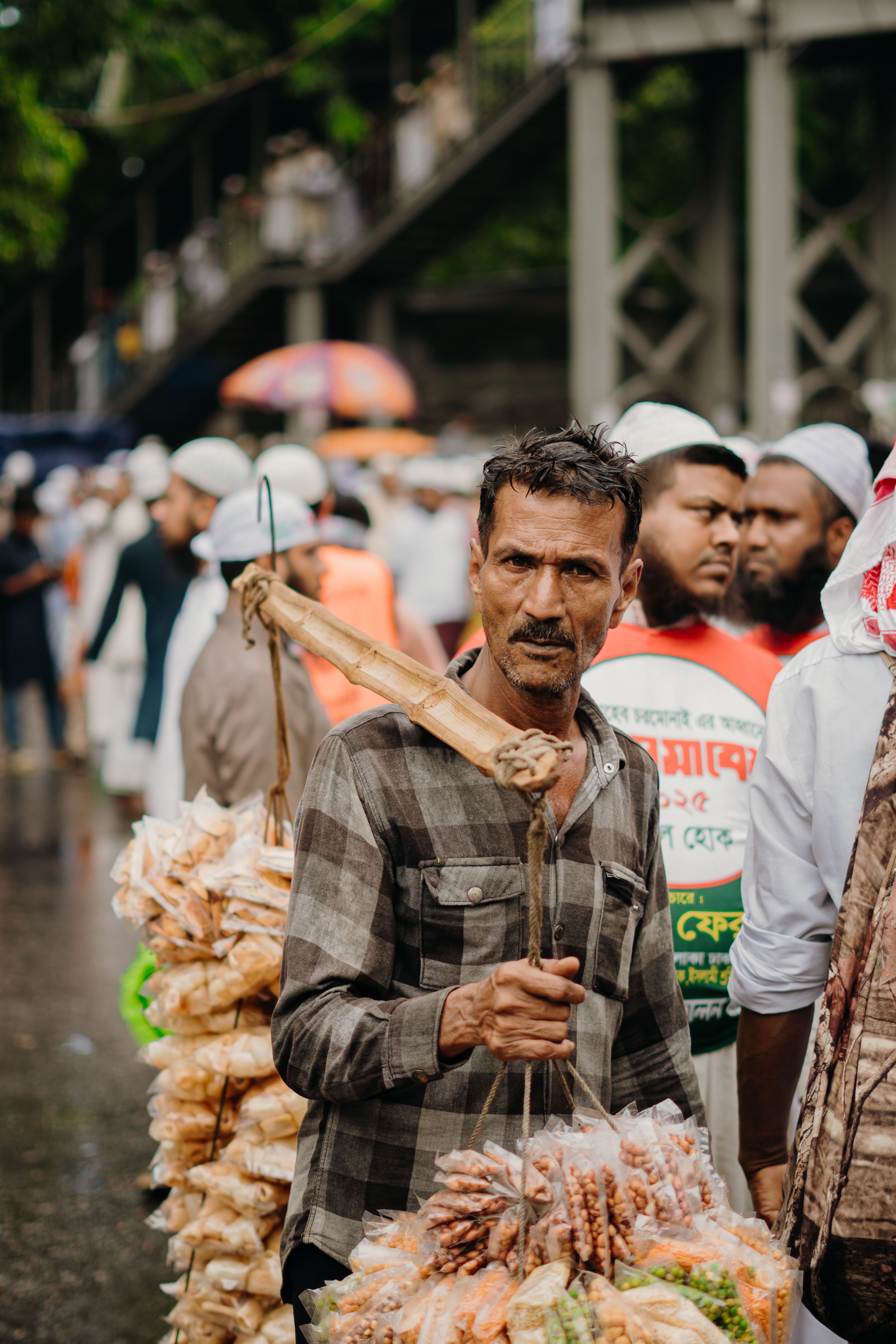 Street Vendor Selling Snacks in Bustling Market · Free Stock Photo