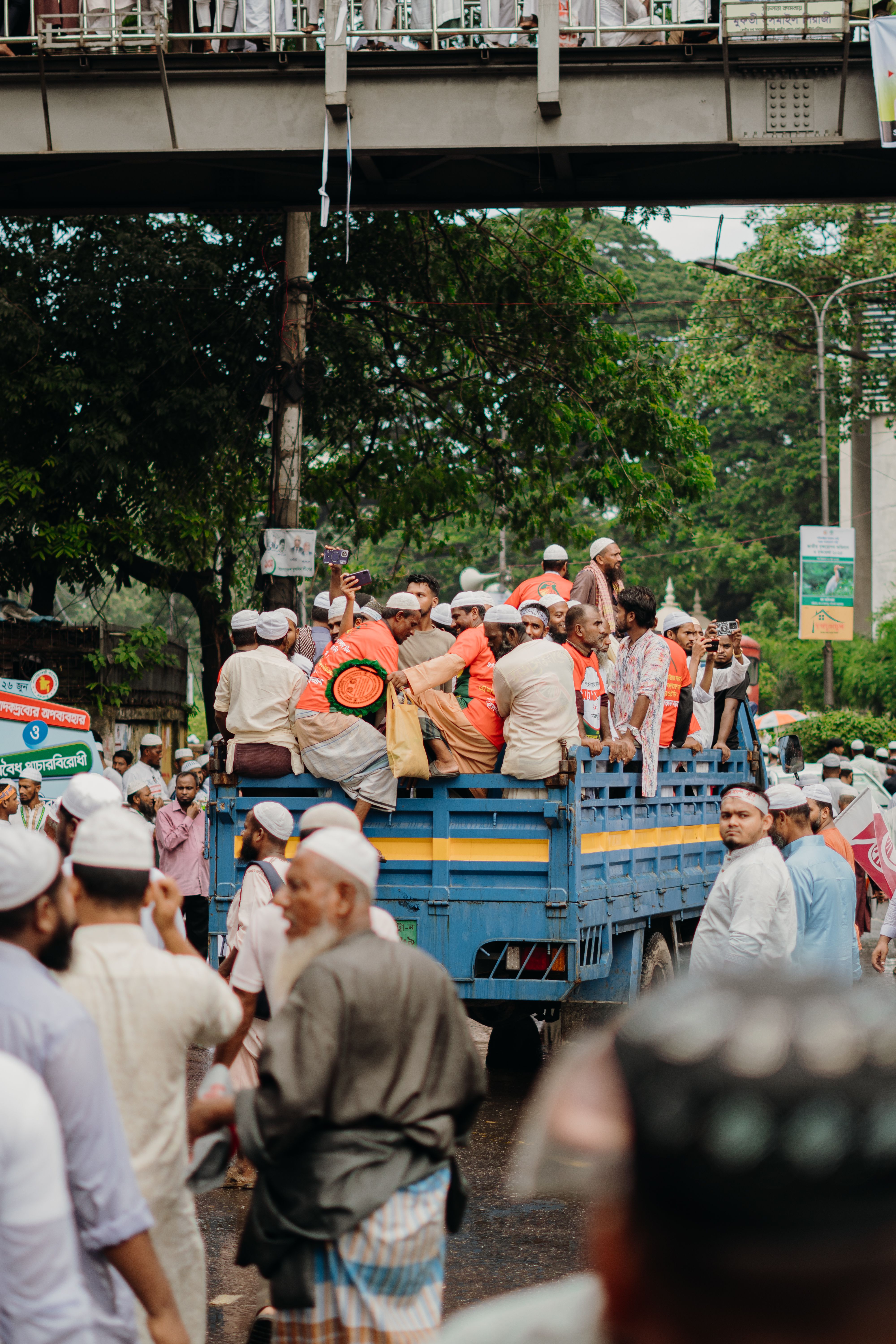 Crowded Street Scene with People on Truck · Free Stock Photo