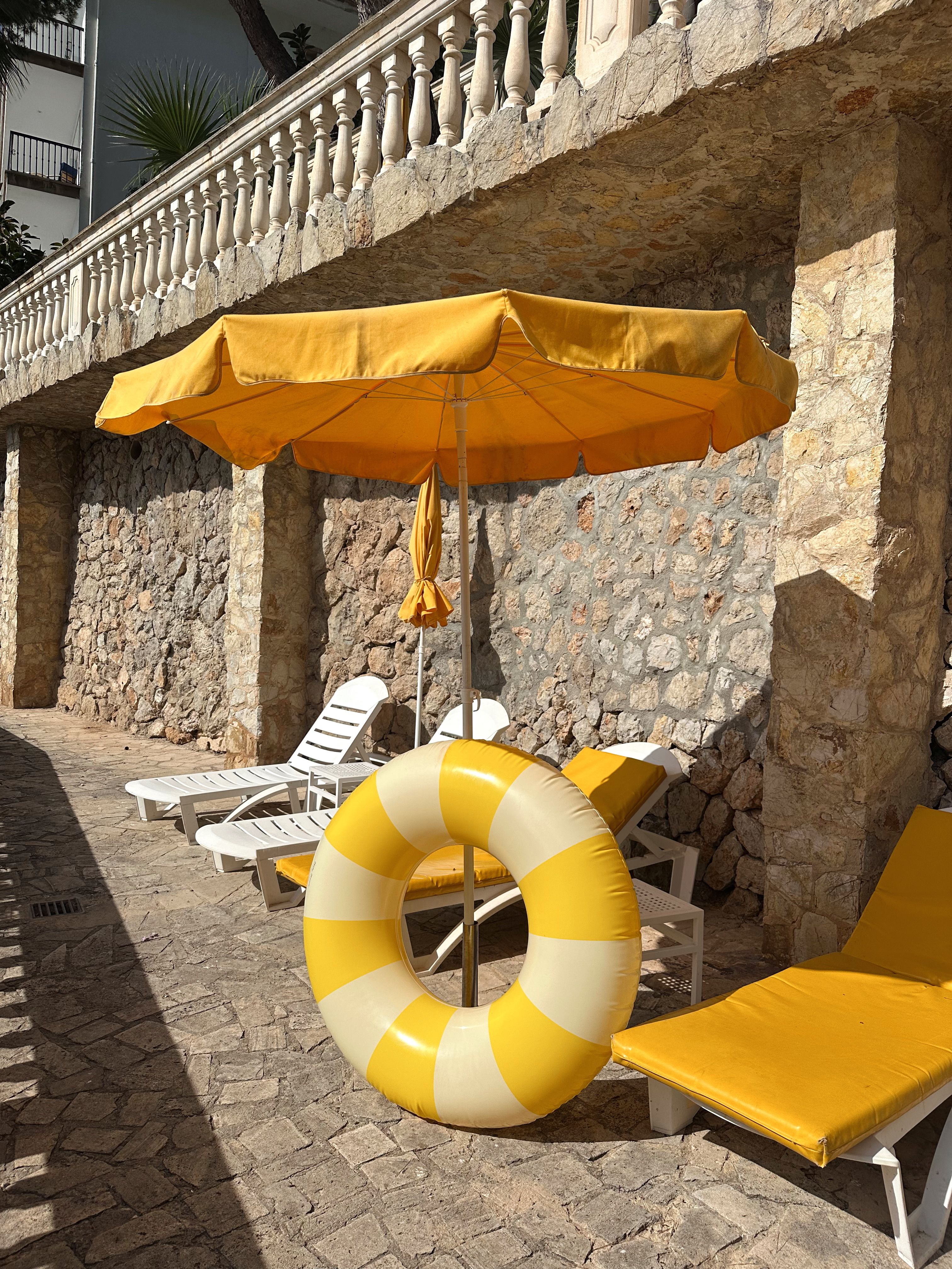Sunny Poolside Oasis with Yellow Umbrella · Free Stock Photo