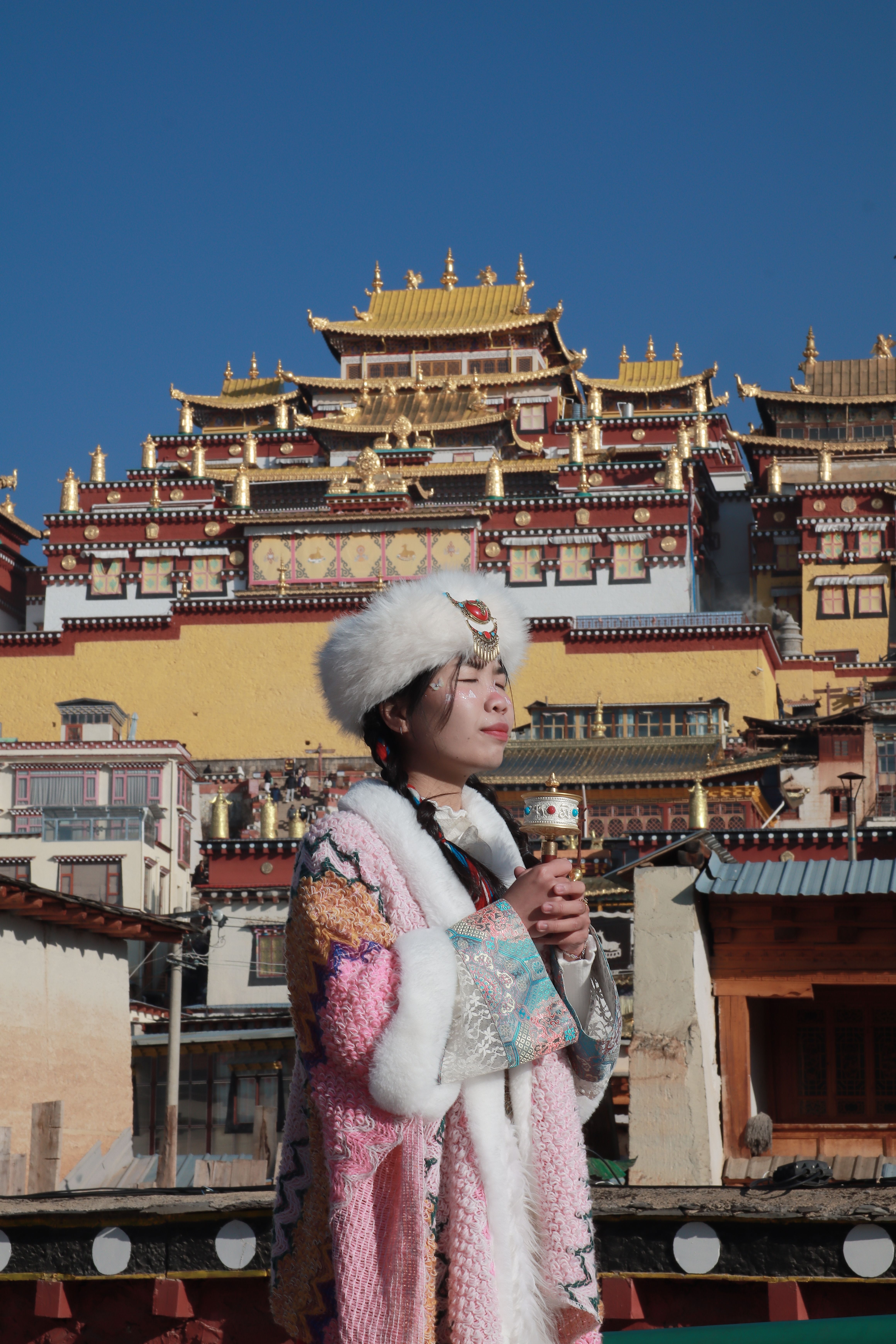 Traditional Attire in Front of Tibetan Monastery · Free Stock Photo