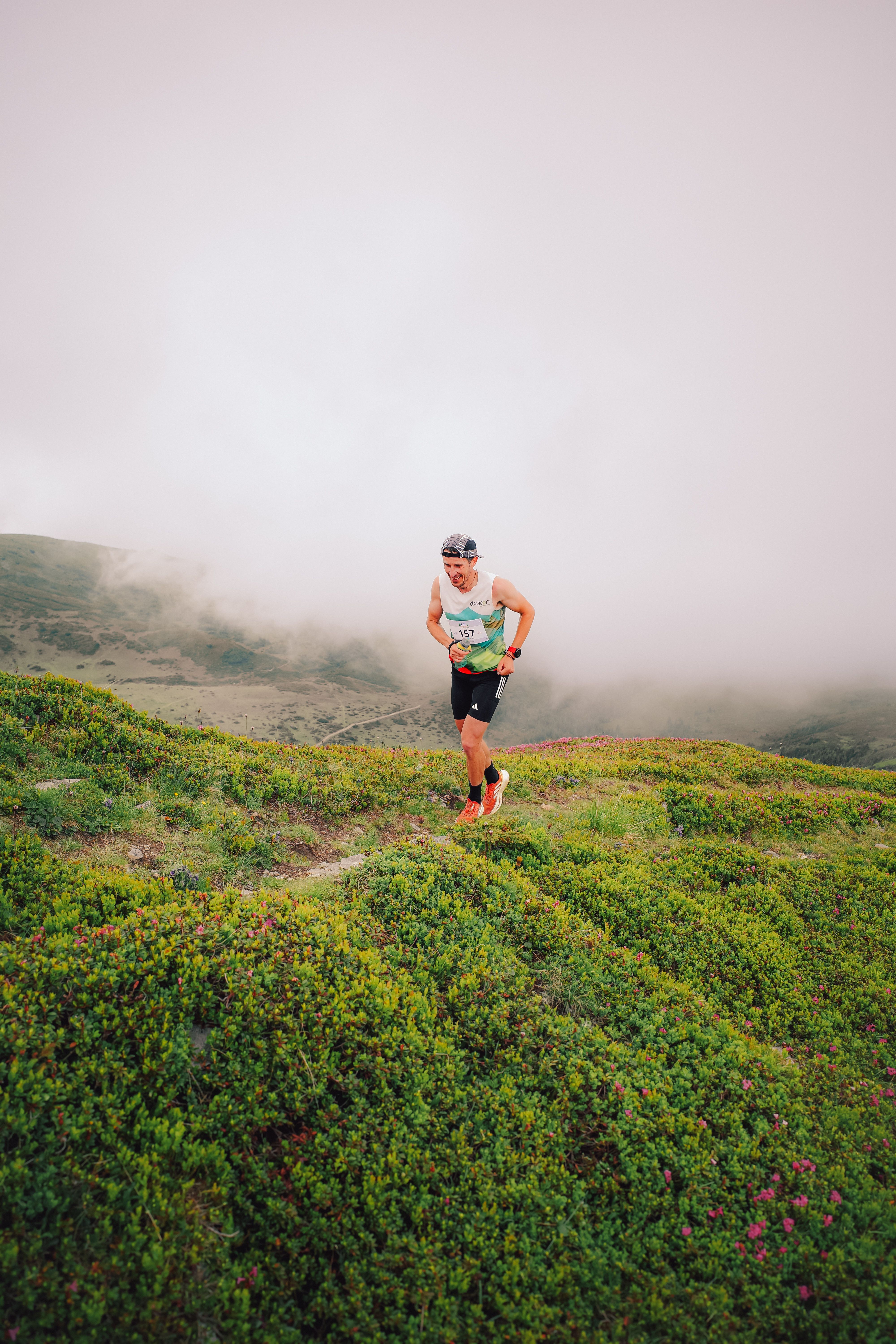 Trail Runner in Misty Landscape on Green Hills · Free Stock Photo