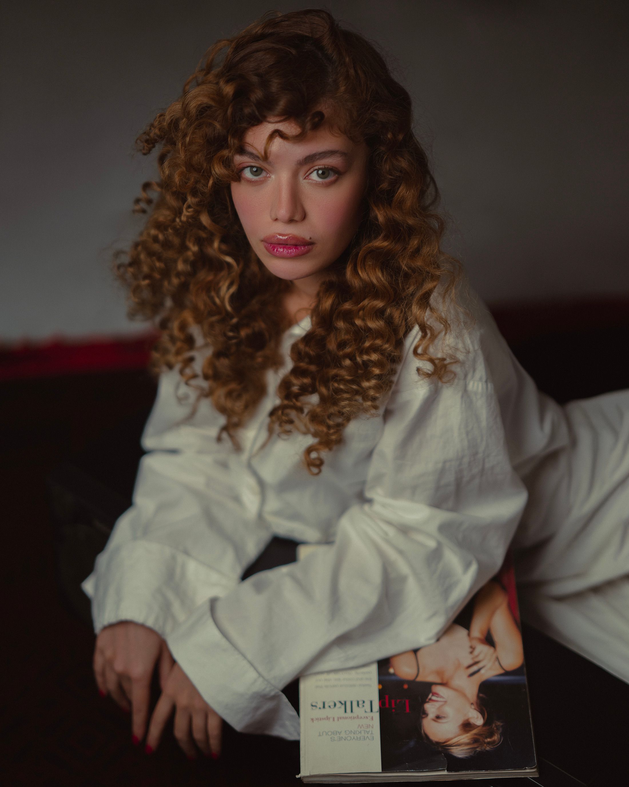 Portrait of Woman with Curly Hair and Magazine · Free Stock Photo