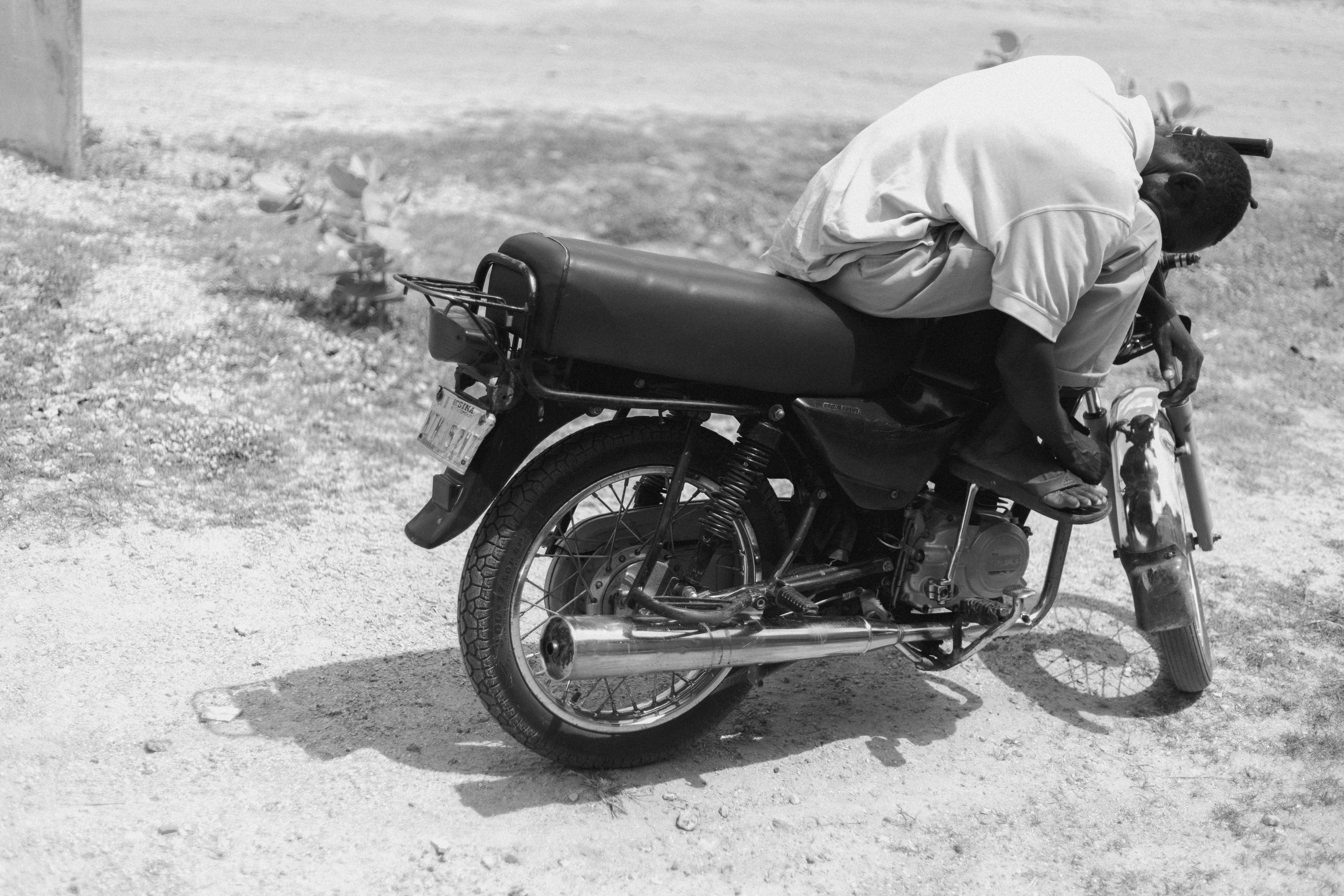 Man Resting on Motorcycle in Sunlit Outdoors · Free Stock Photo
