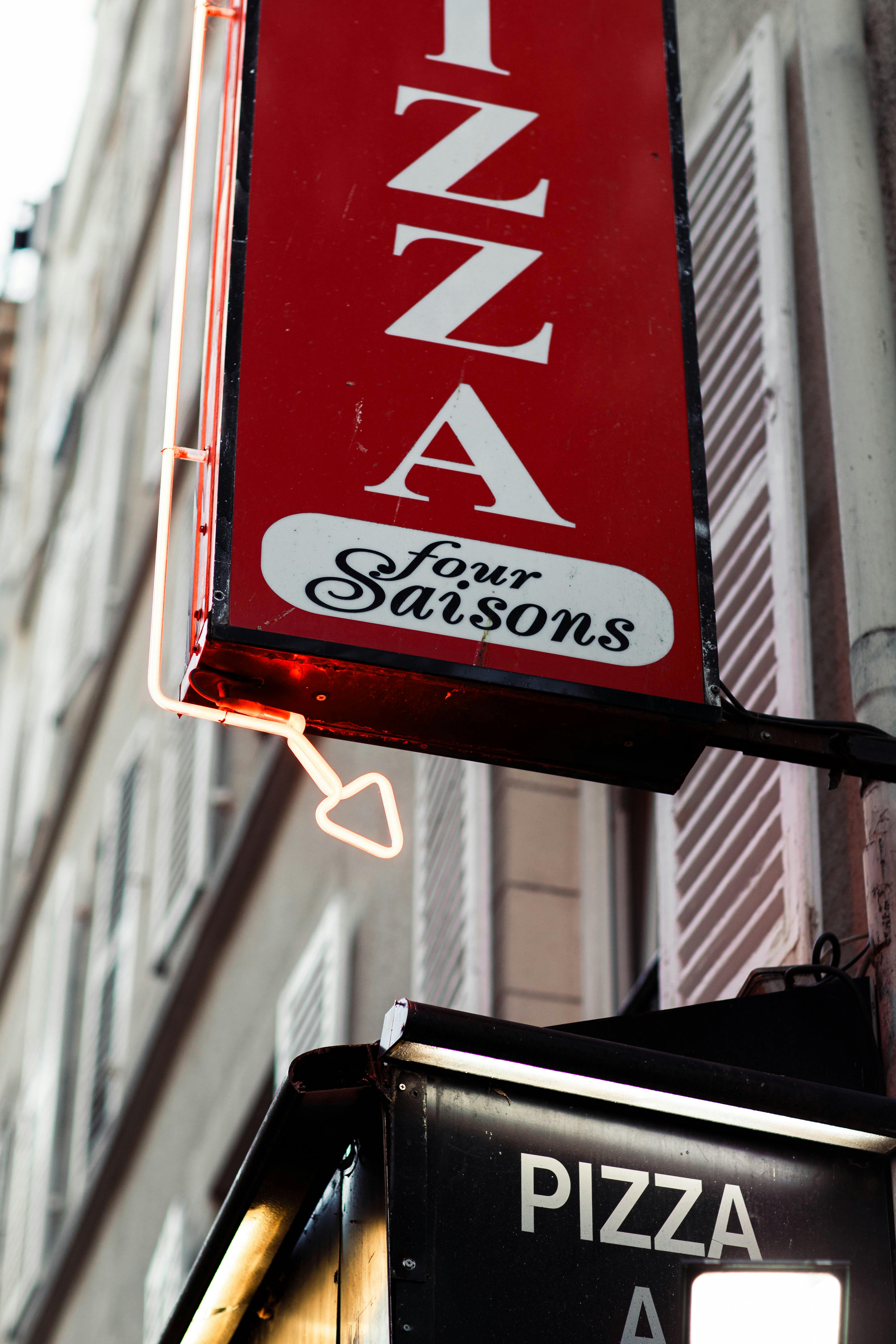 Urban Evening Scene of Pizza Restaurant Sign · Free Stock Photo