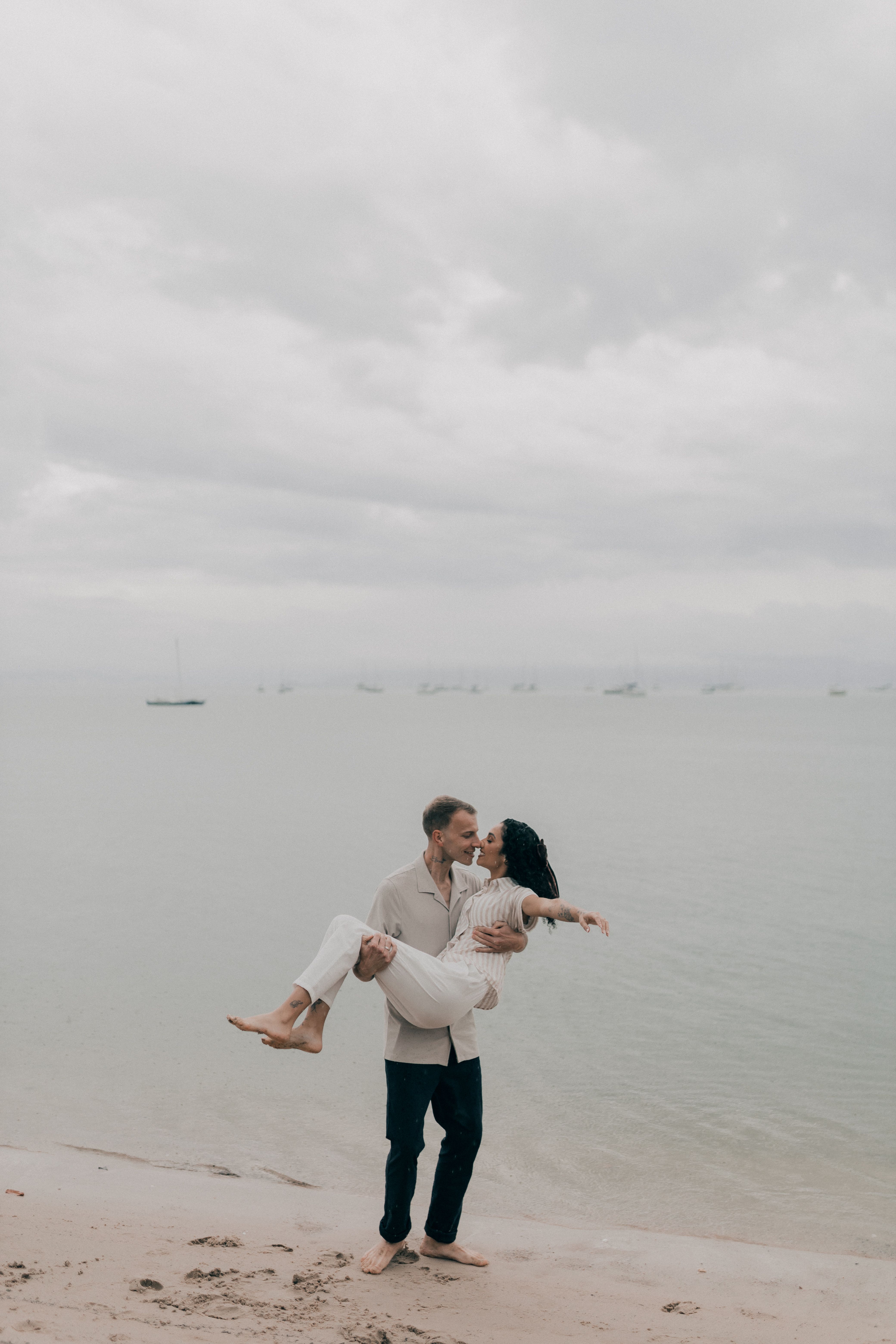 Happy Couple Embracing on Beach · Free Stock Photo