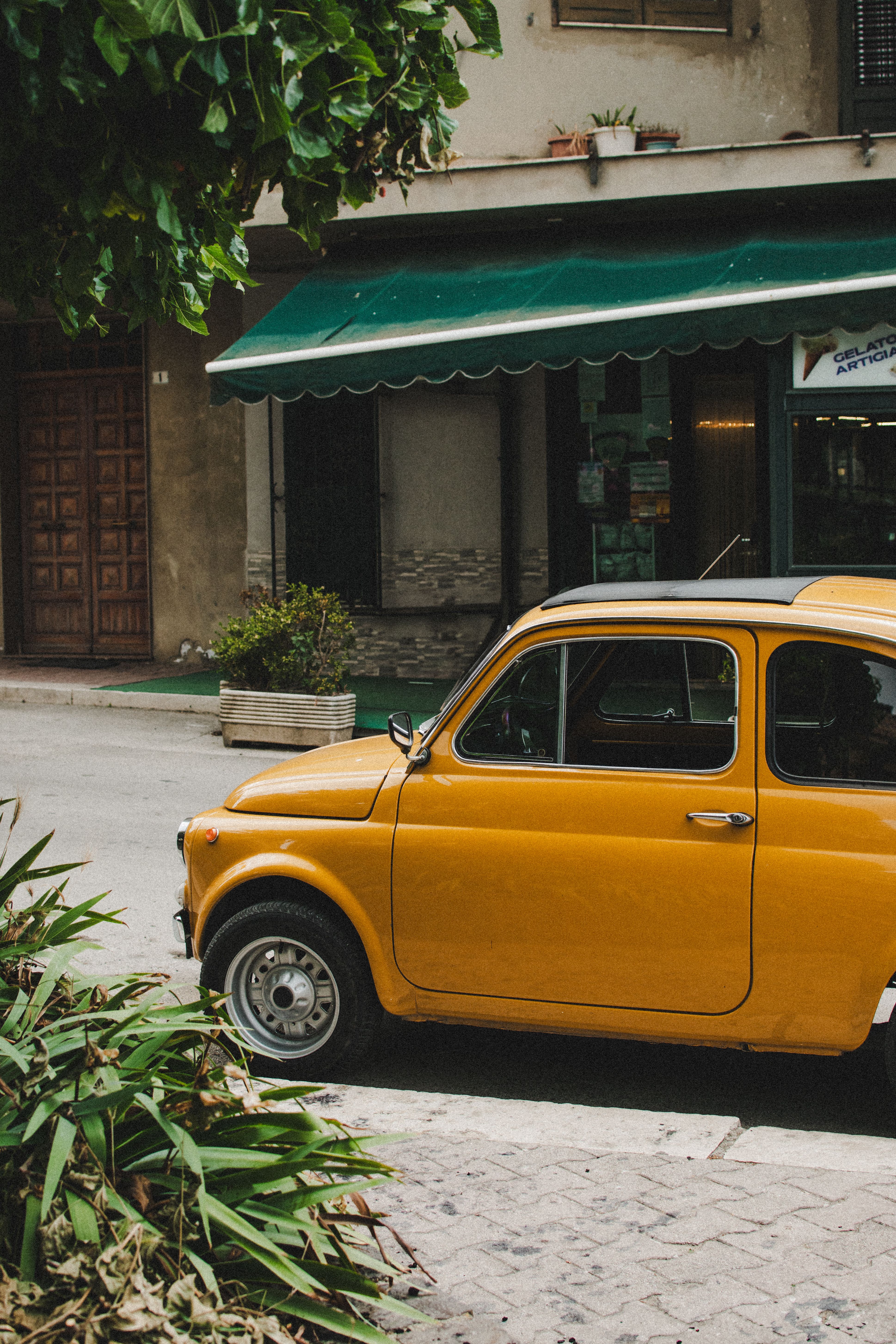 Classic Yellow Car on Side of Road at Day · Free Stock Photo