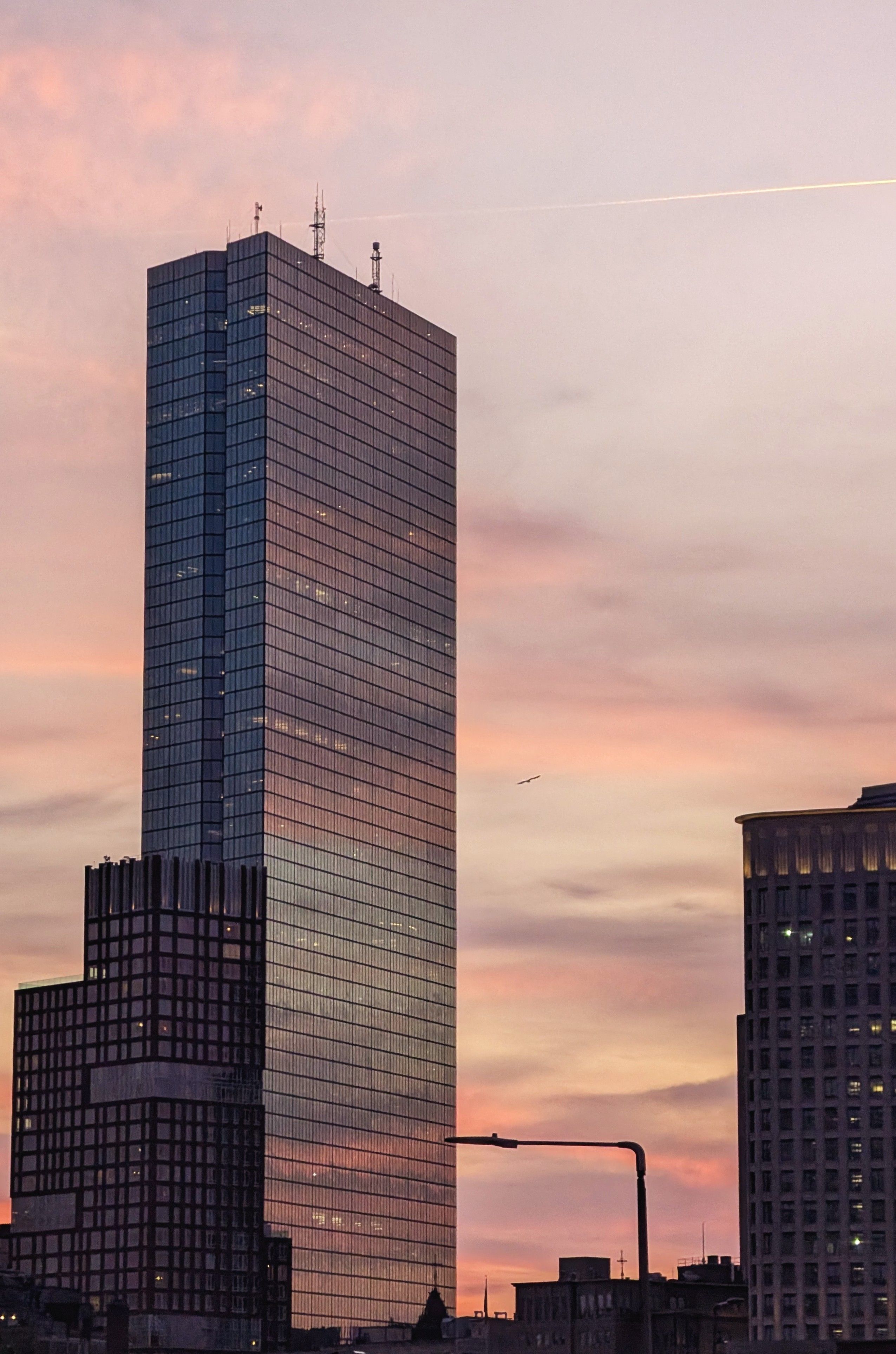 Sunset Skyline with Modern Glass Skyscraper · Free Stock Photo