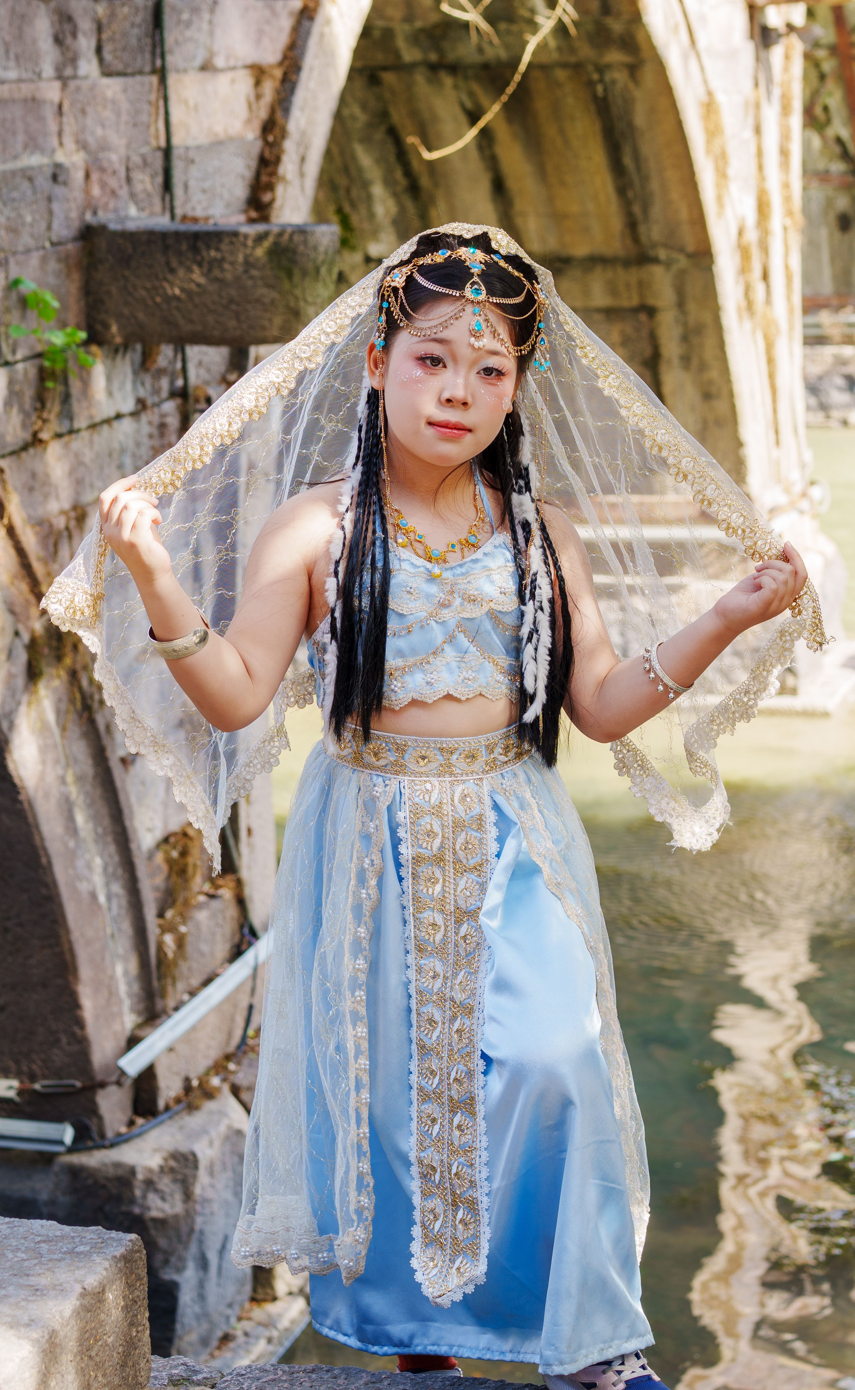 Young Girl in Cultural Costume Near Historical Site · Free Stock Photo