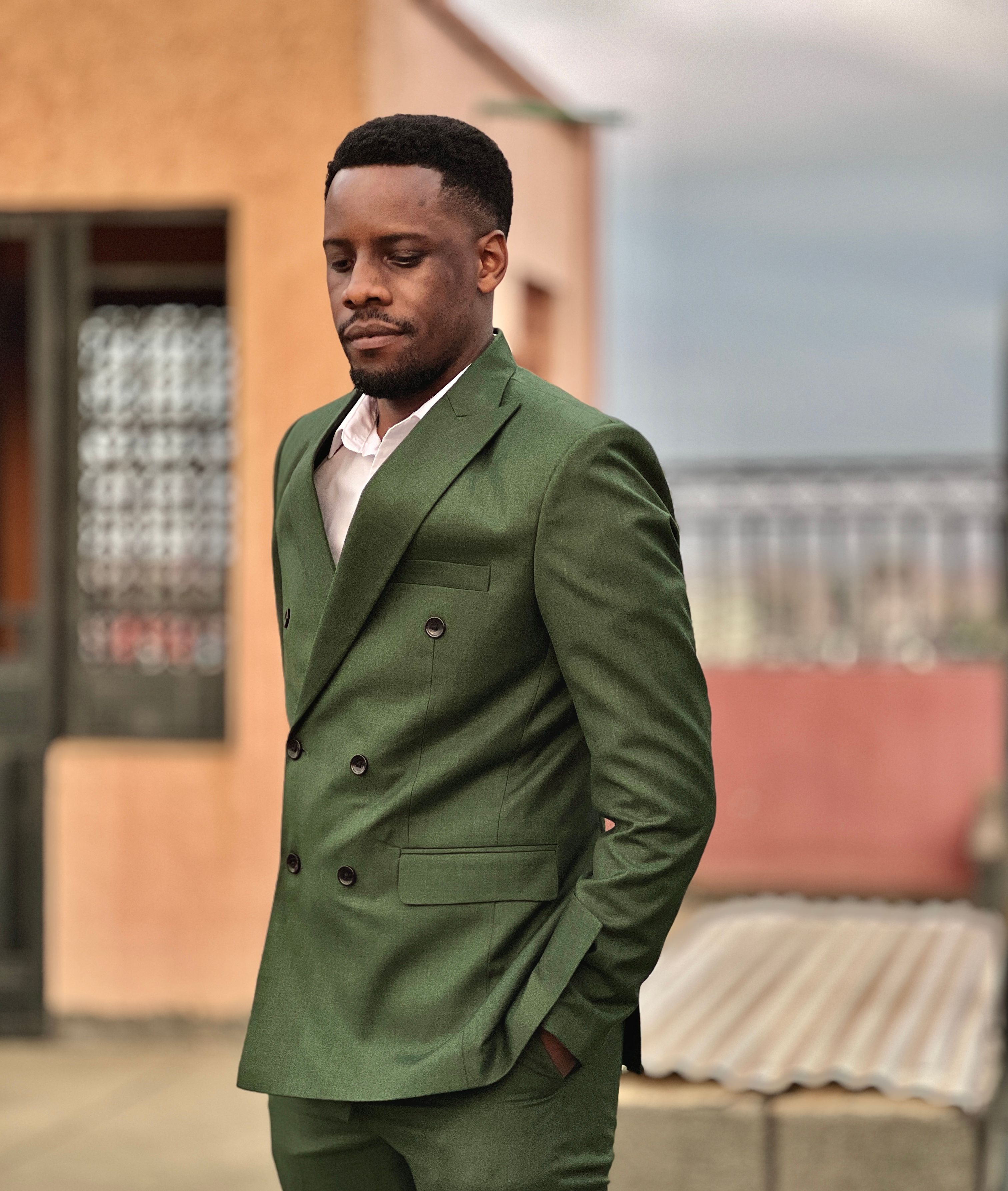 Stylish Man in Green Suit on Rooftop · Free Stock Photo