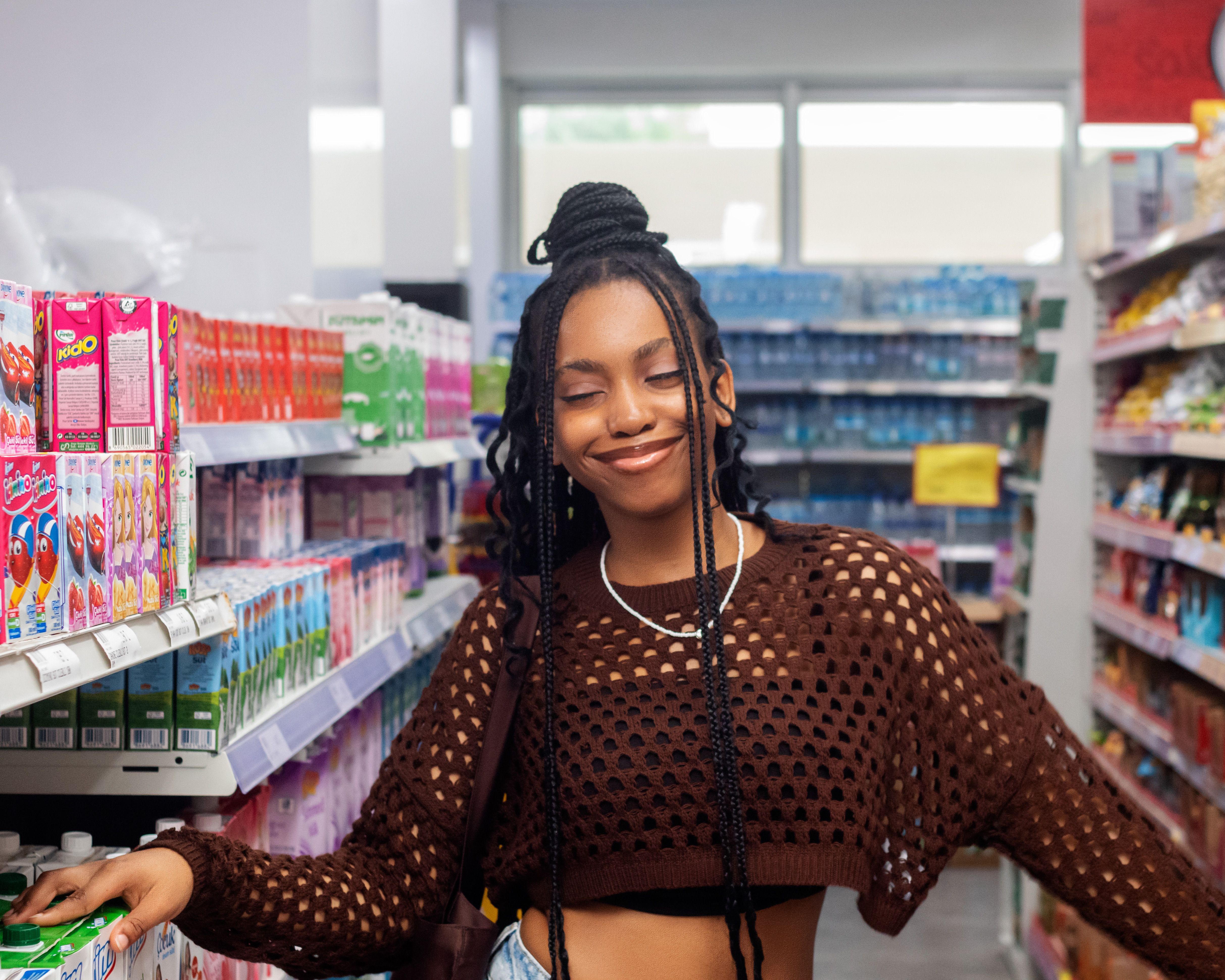 Smiling Young Woman Shopping in Grocery Store · Free Stock Photo