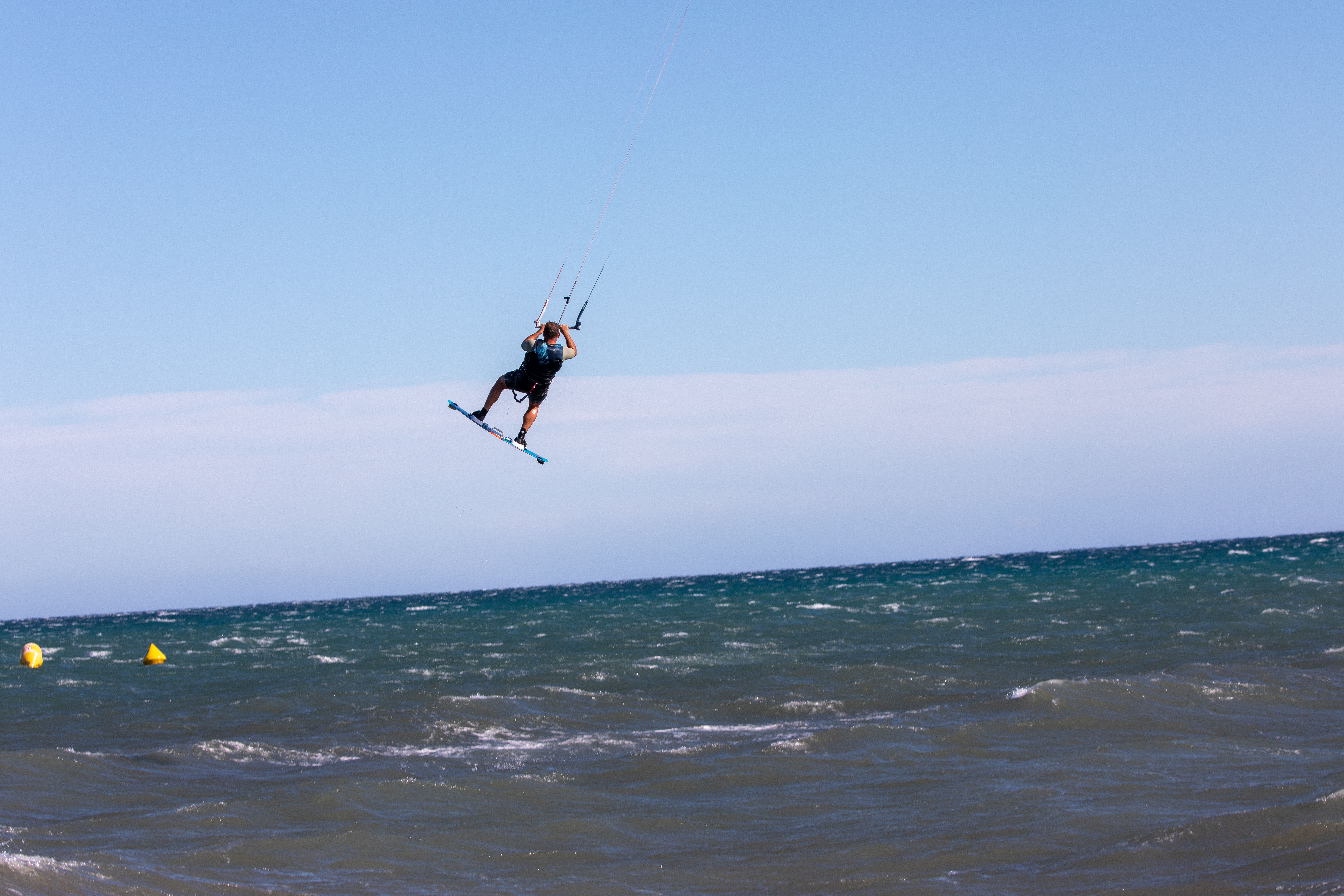 Dynamic Kiteboarding Over Ocean Waves at Sea · Free Stock Photo