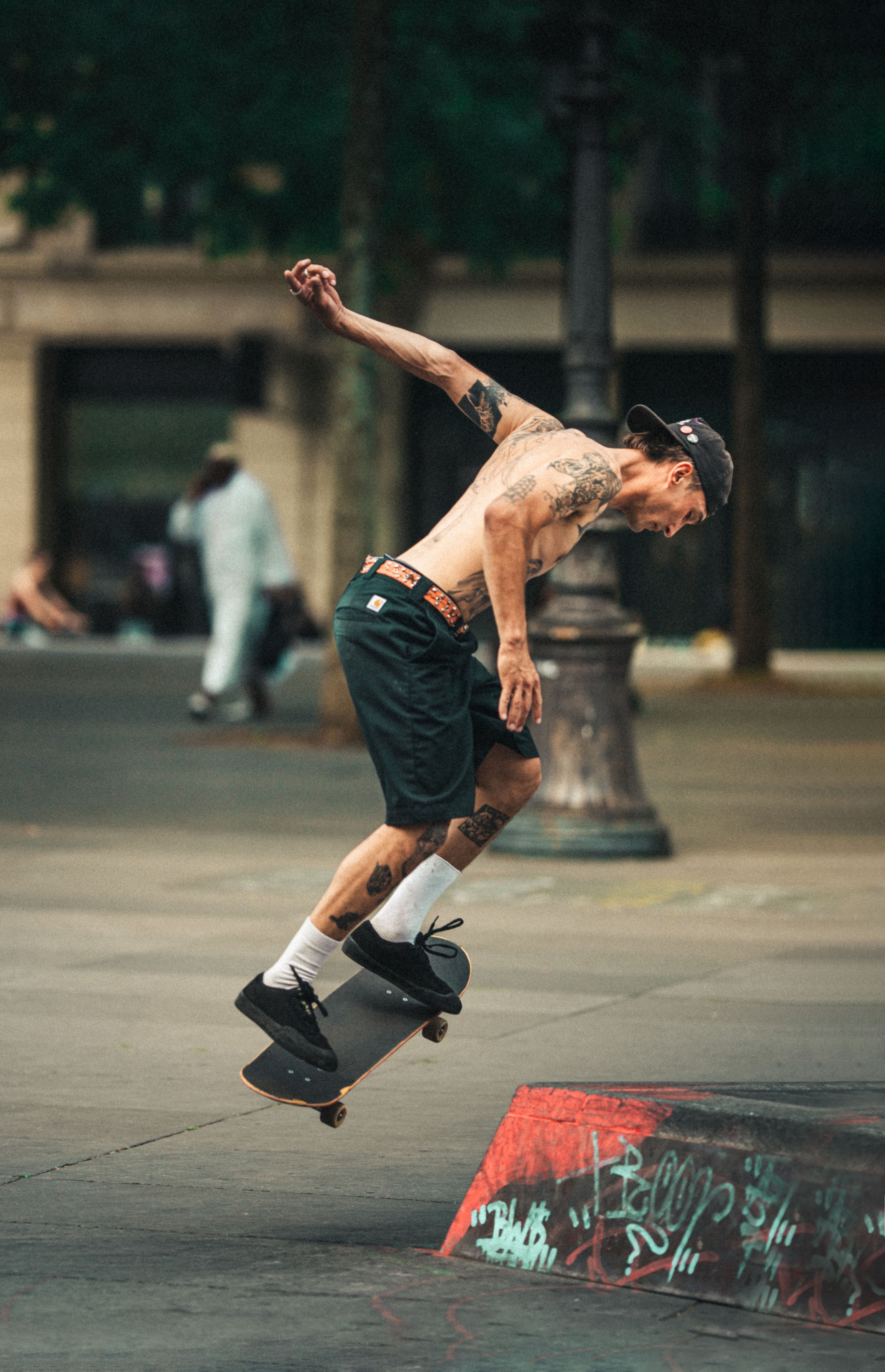 Skateboarder Performing Tricks in Urban Street Scene · Free Stock Photo