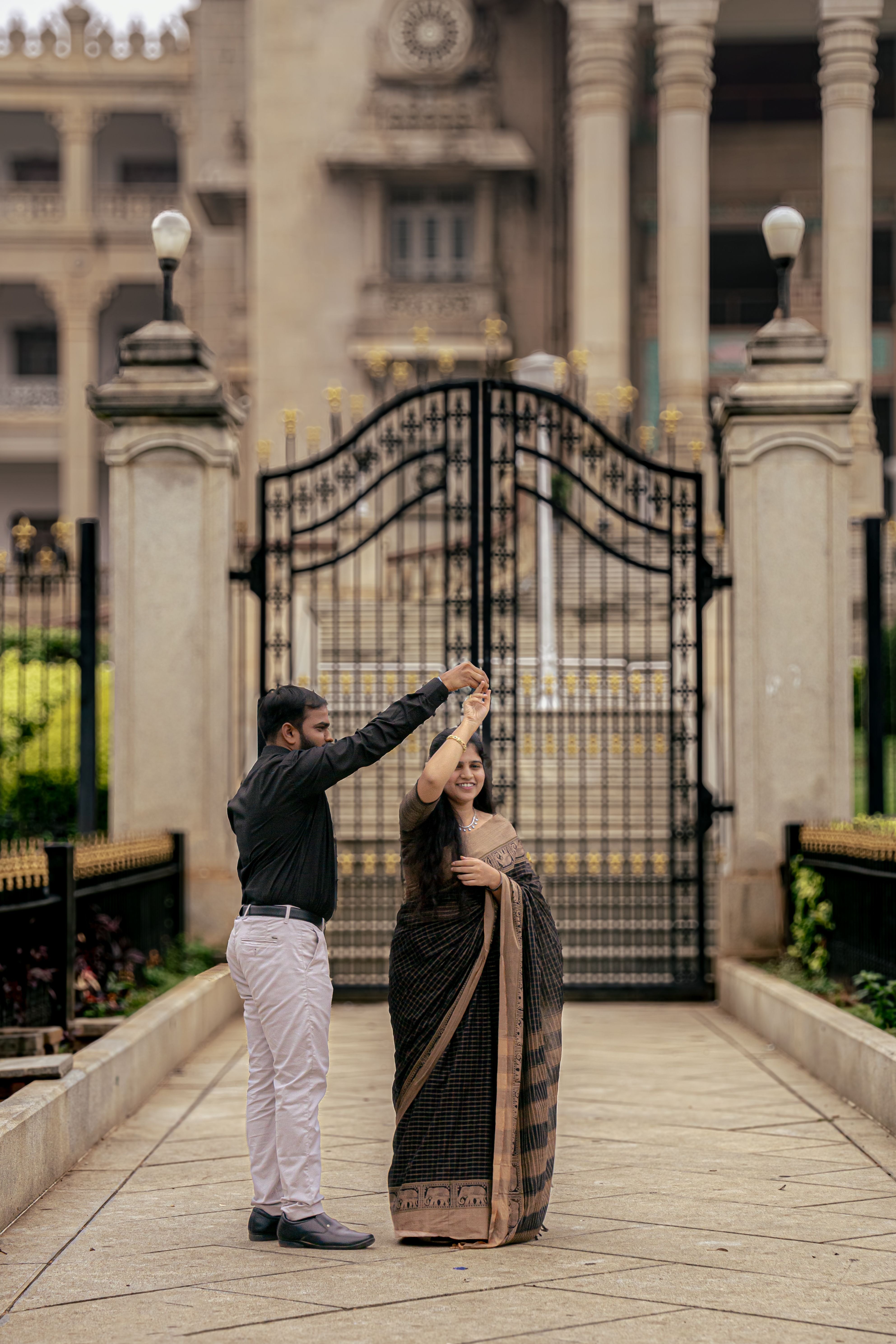 Couple Dancing Outside Historic Building Gate · Free Stock Photo