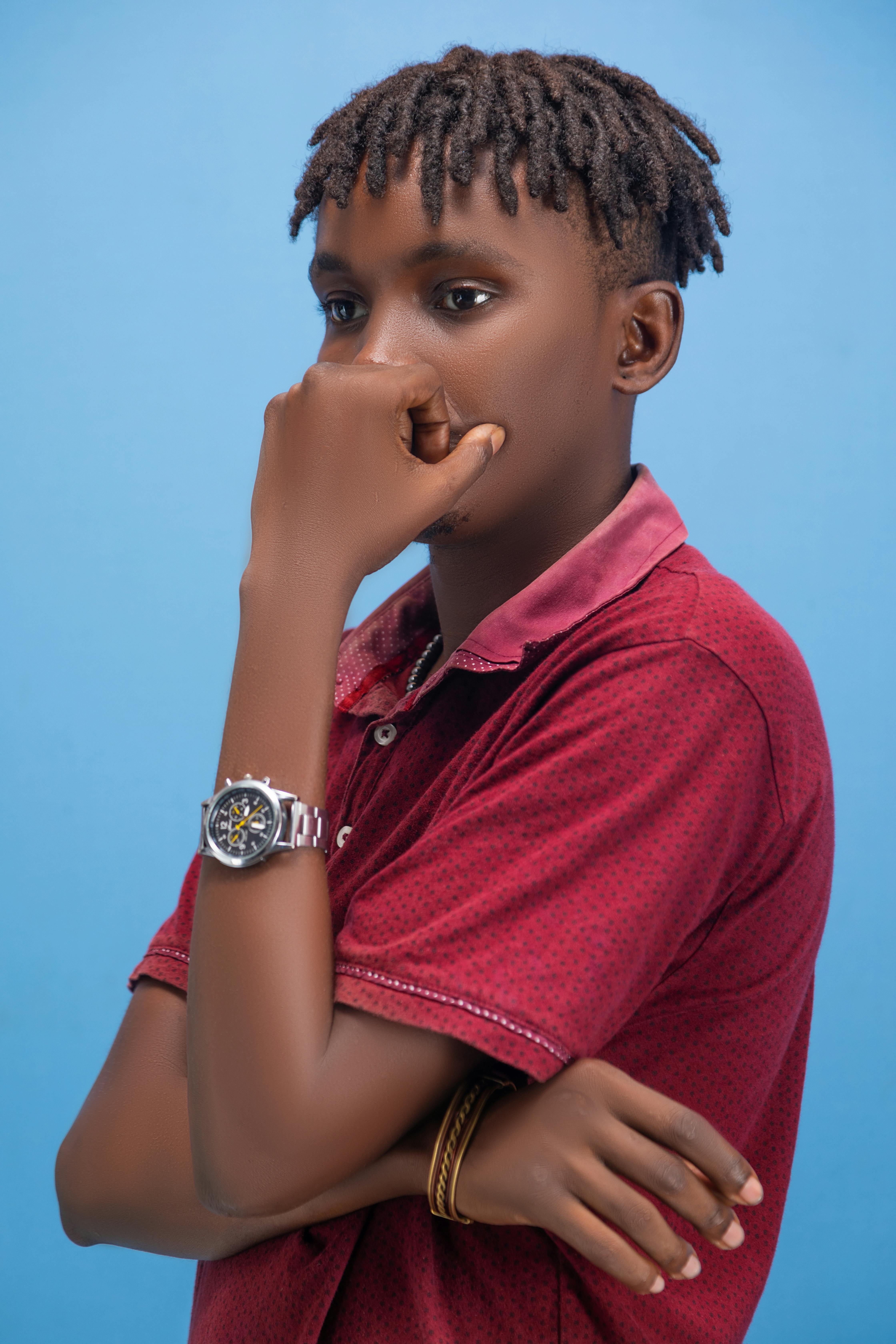 Portrait of Contemplative Young Man on Blue Background · Free Stock Photo