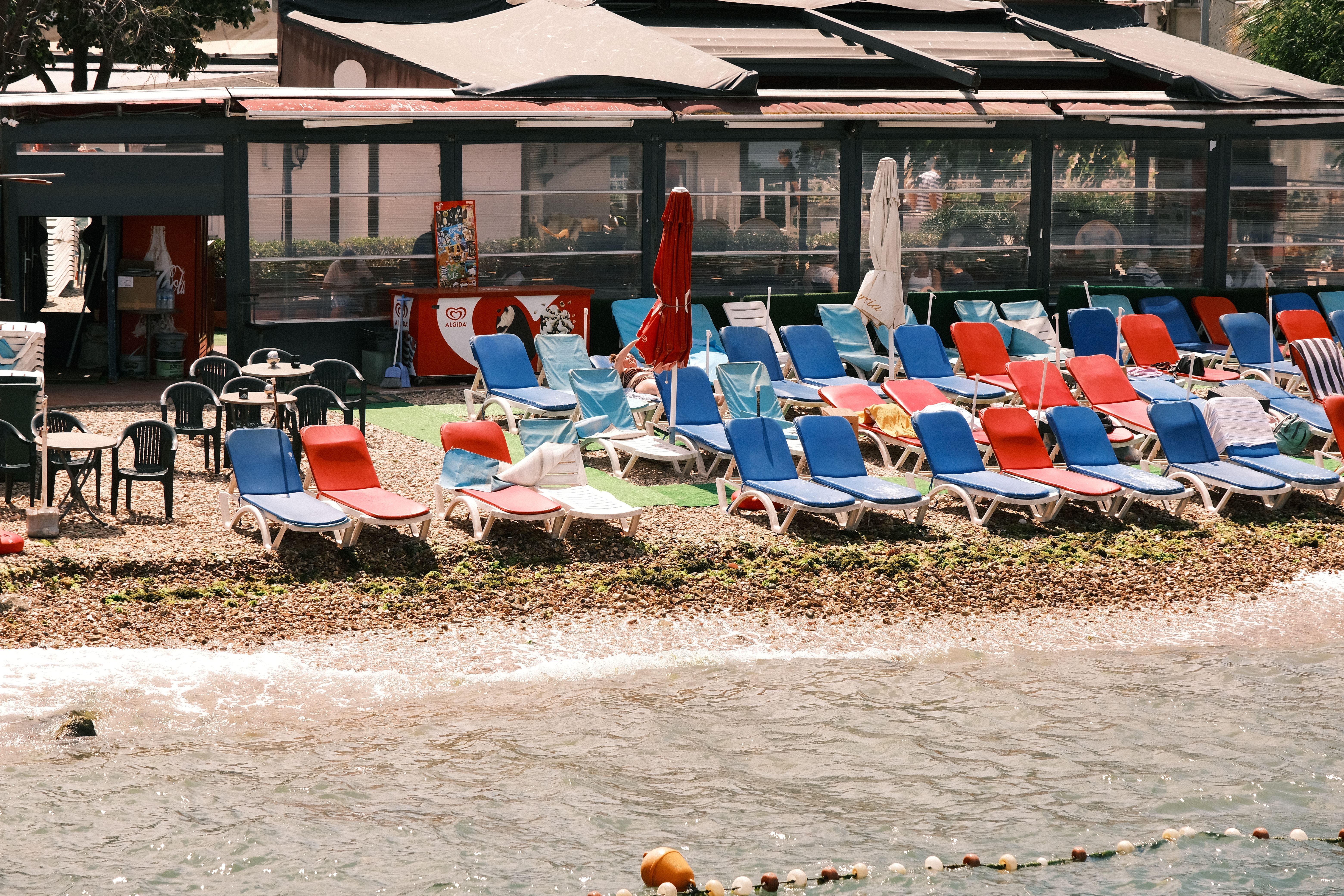 Colorful Beach Loungers and Seaside Café View · Free Stock Photo