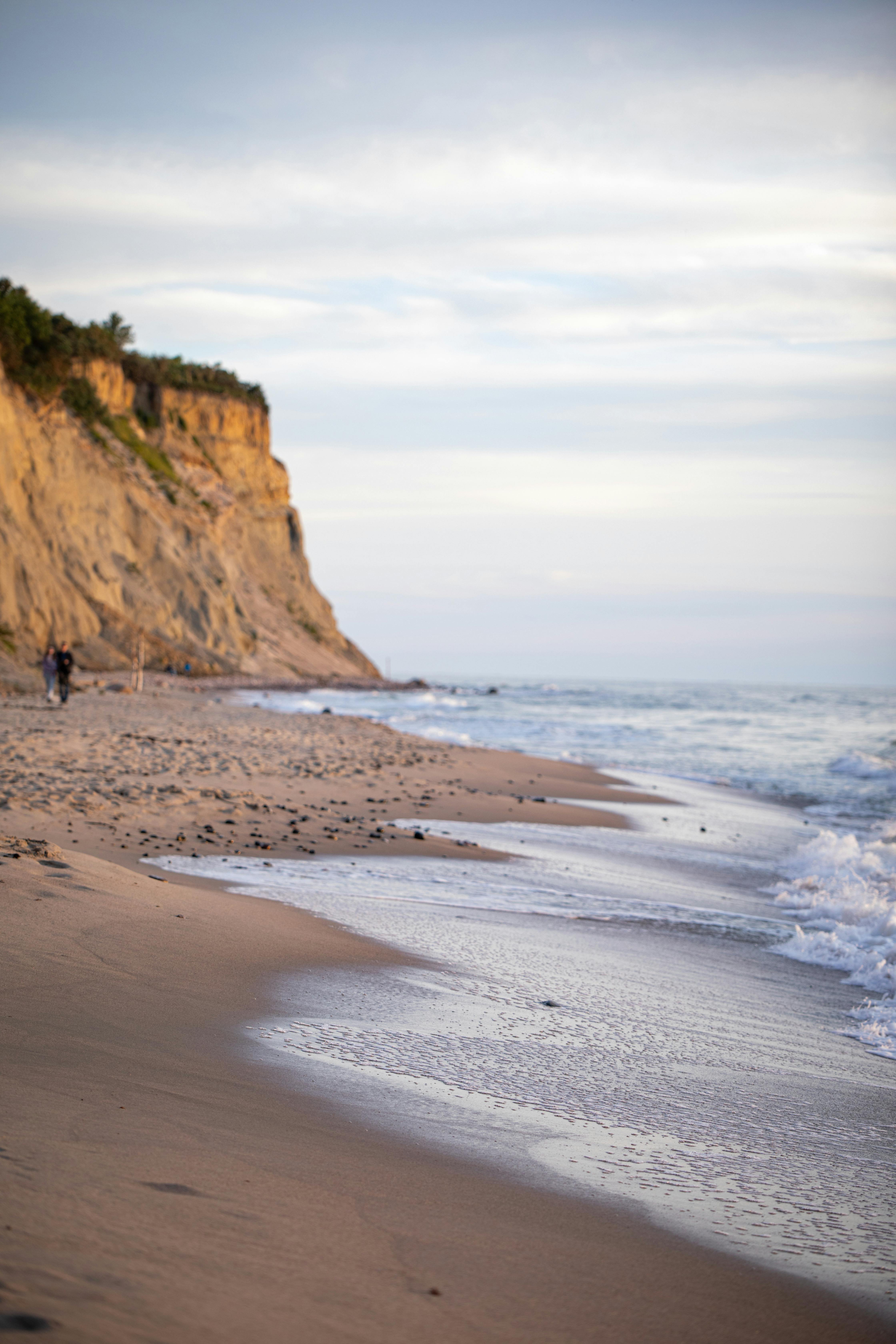 Serene Coastal Cliffside Beach at Sunset · Free Stock Photo