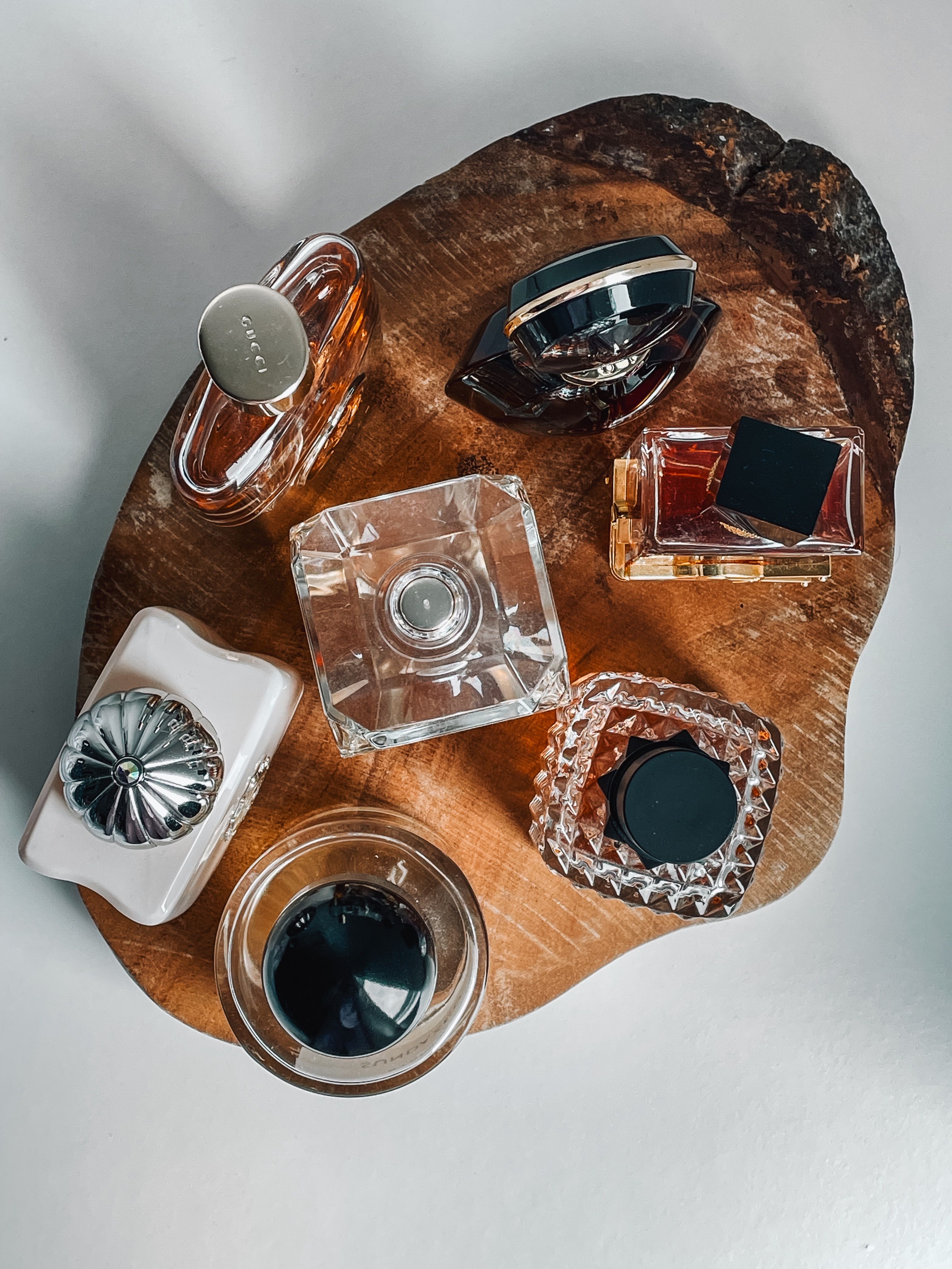 Elegant Perfume Bottles on Rustic Wood Tray · Free Stock Photo