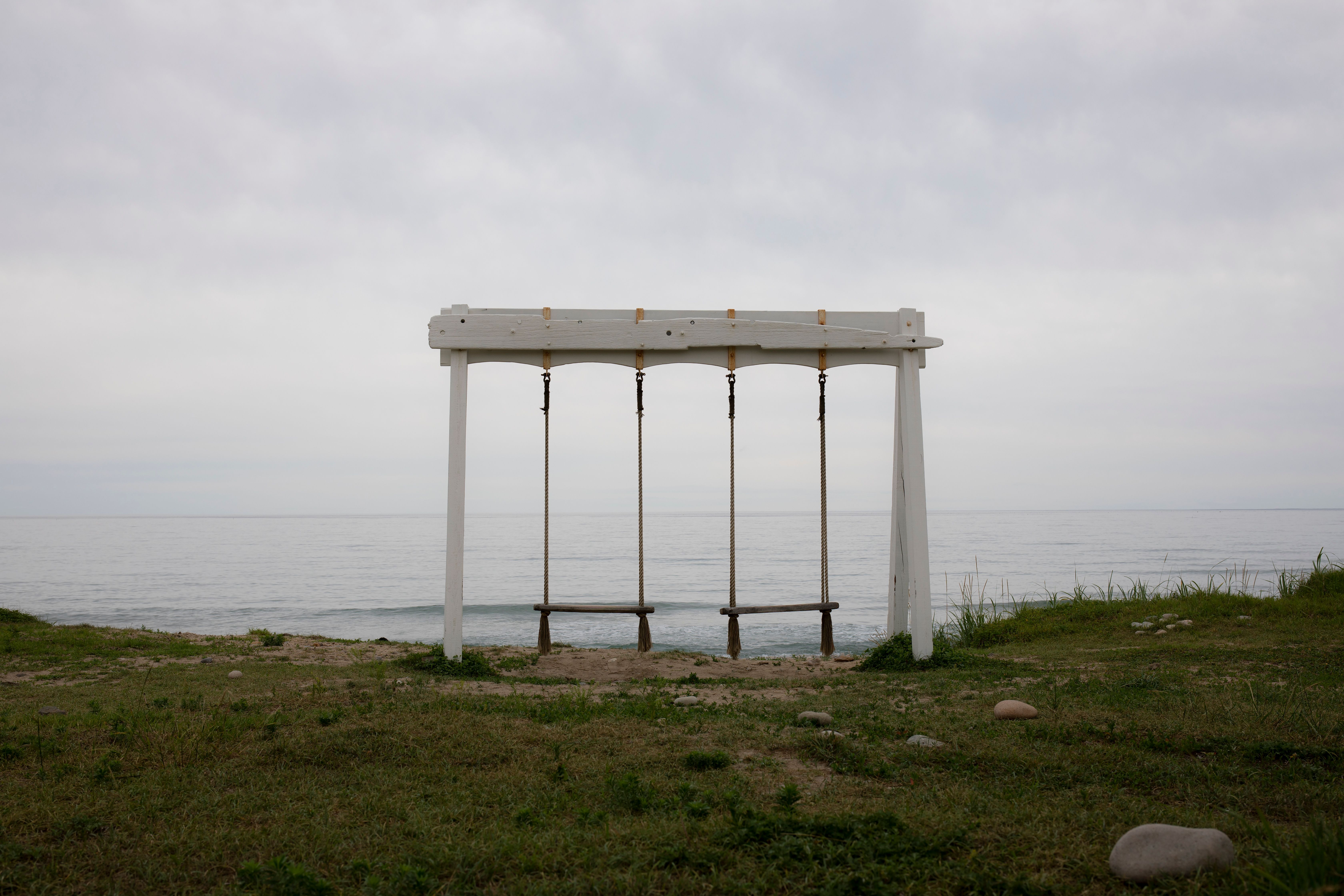 Rustic Swing by the Sea on a Cloudy Day · Free Stock Photo