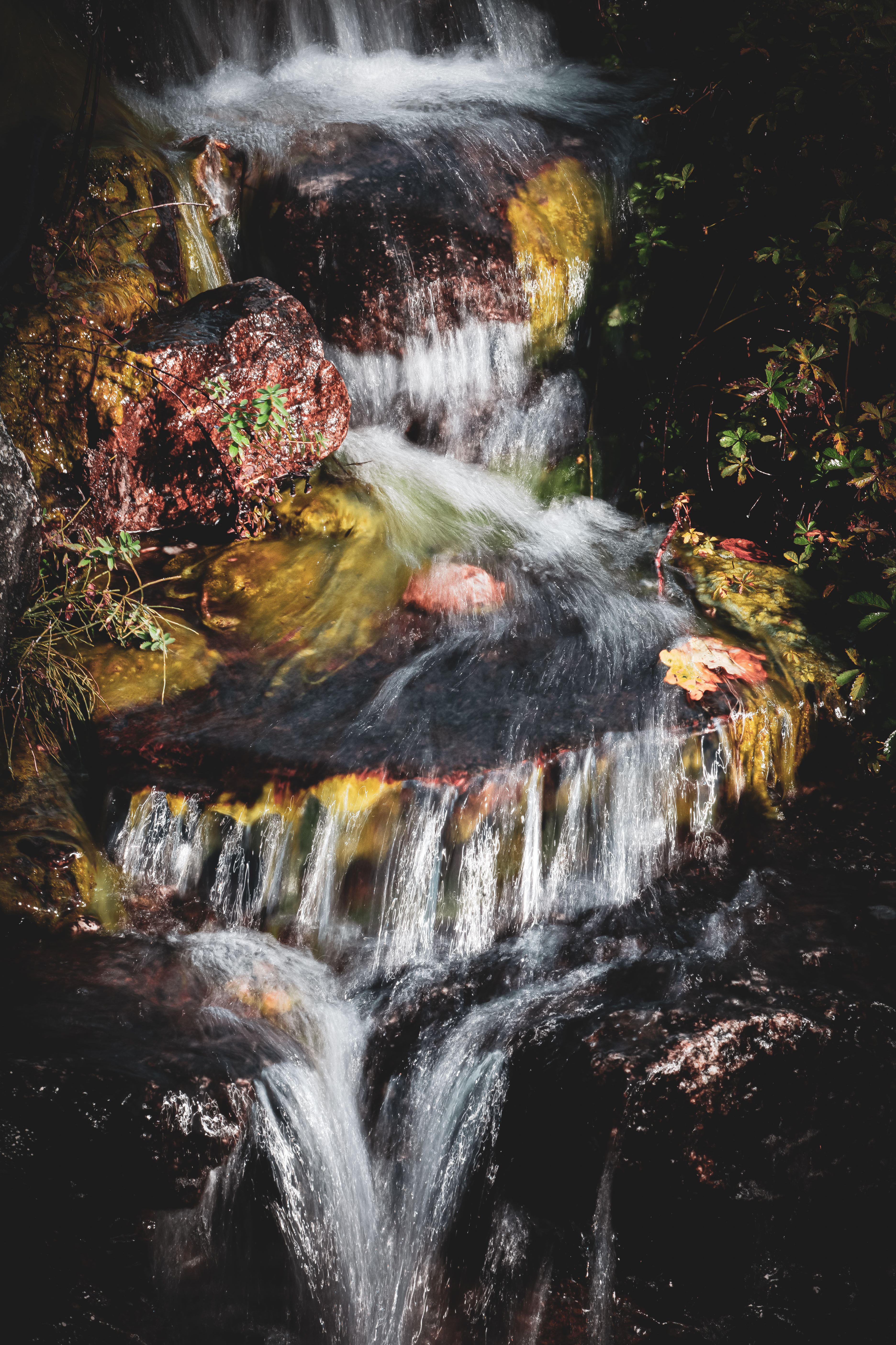 Serene Waterfall Cascade in Lush Forest Setting · Free Stock Photo