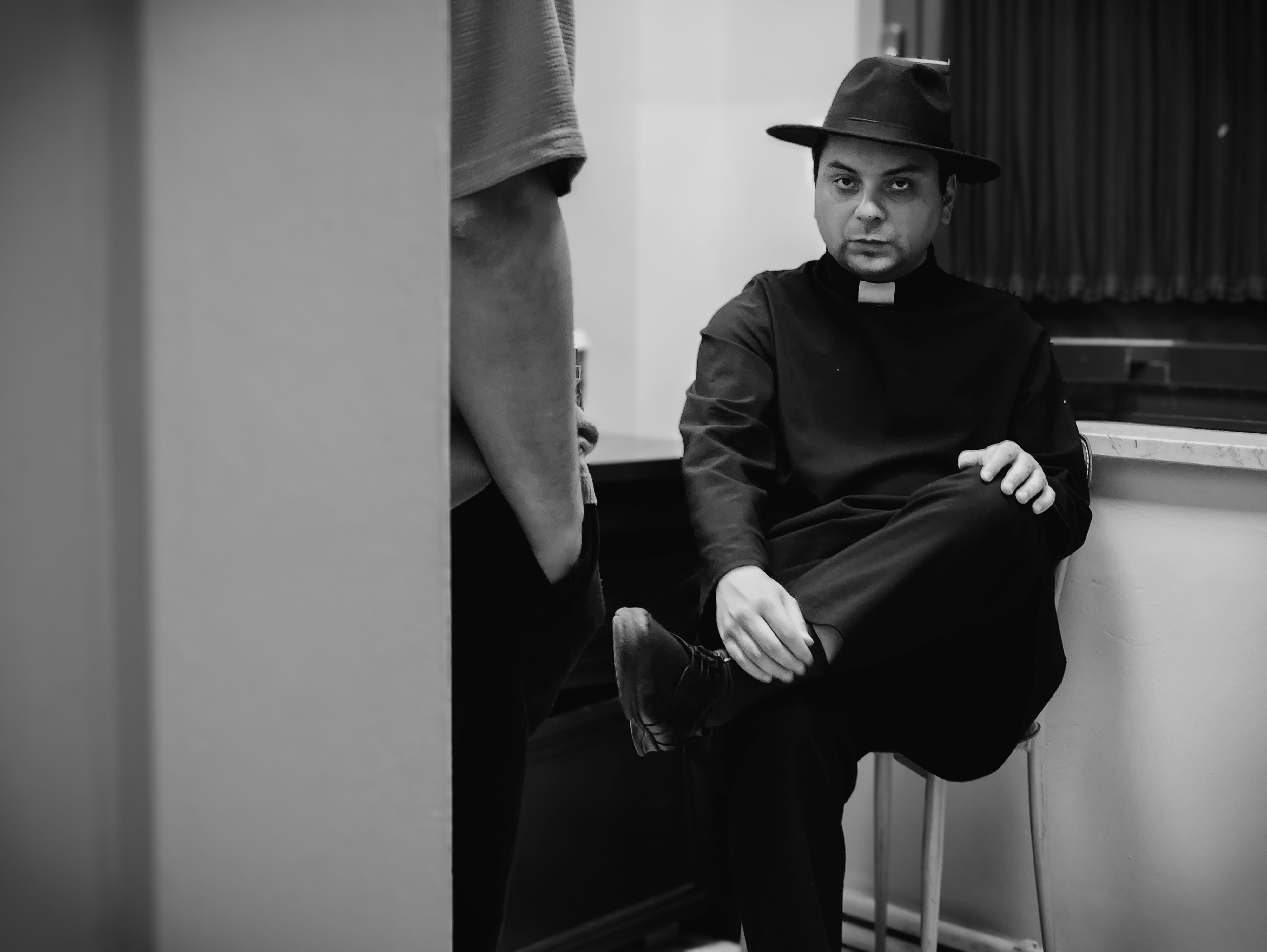 Black and White Portrait of a Seated Priest · Free Stock Photo