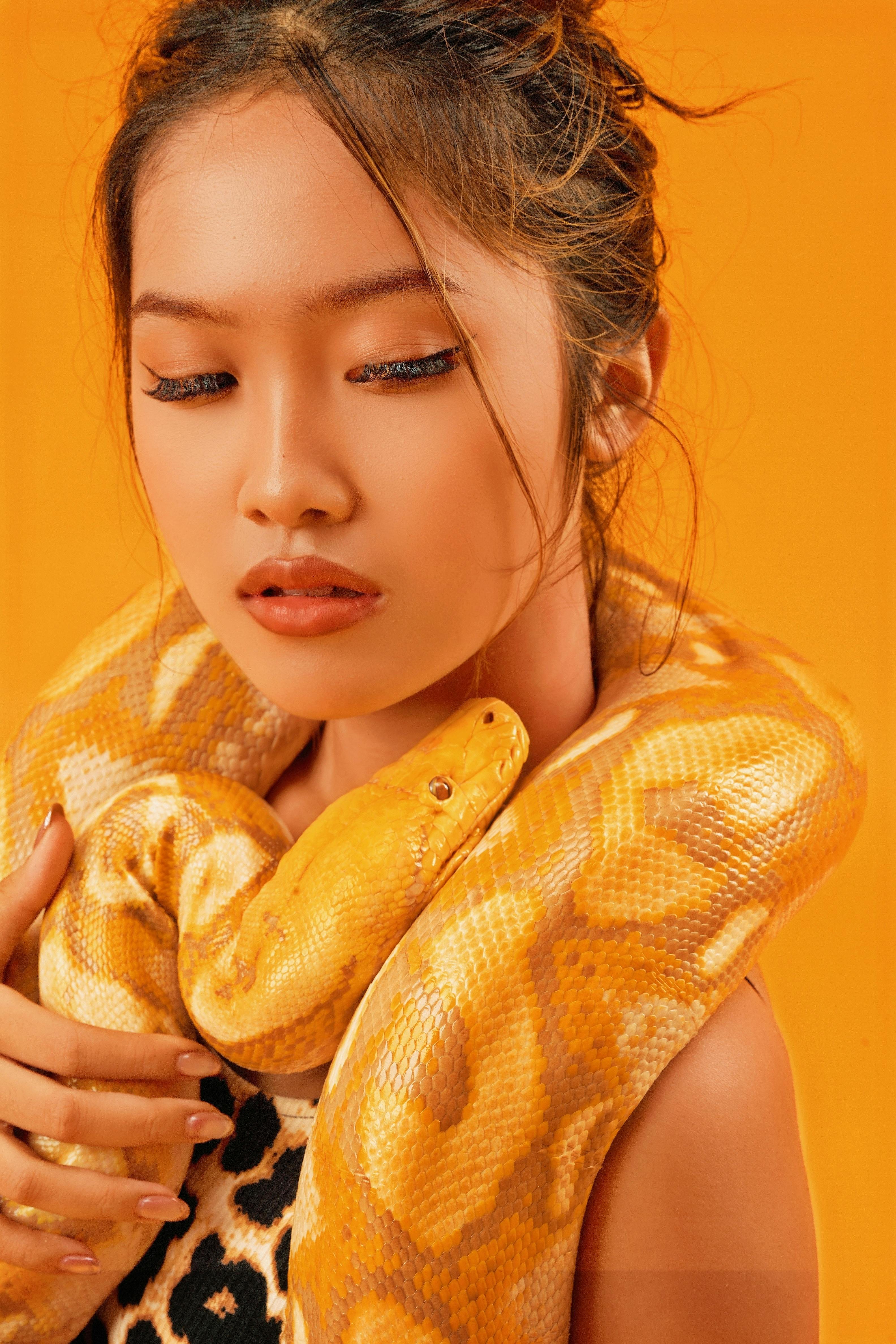 Portrait of a Woman with Yellow Python · Free Stock Photo