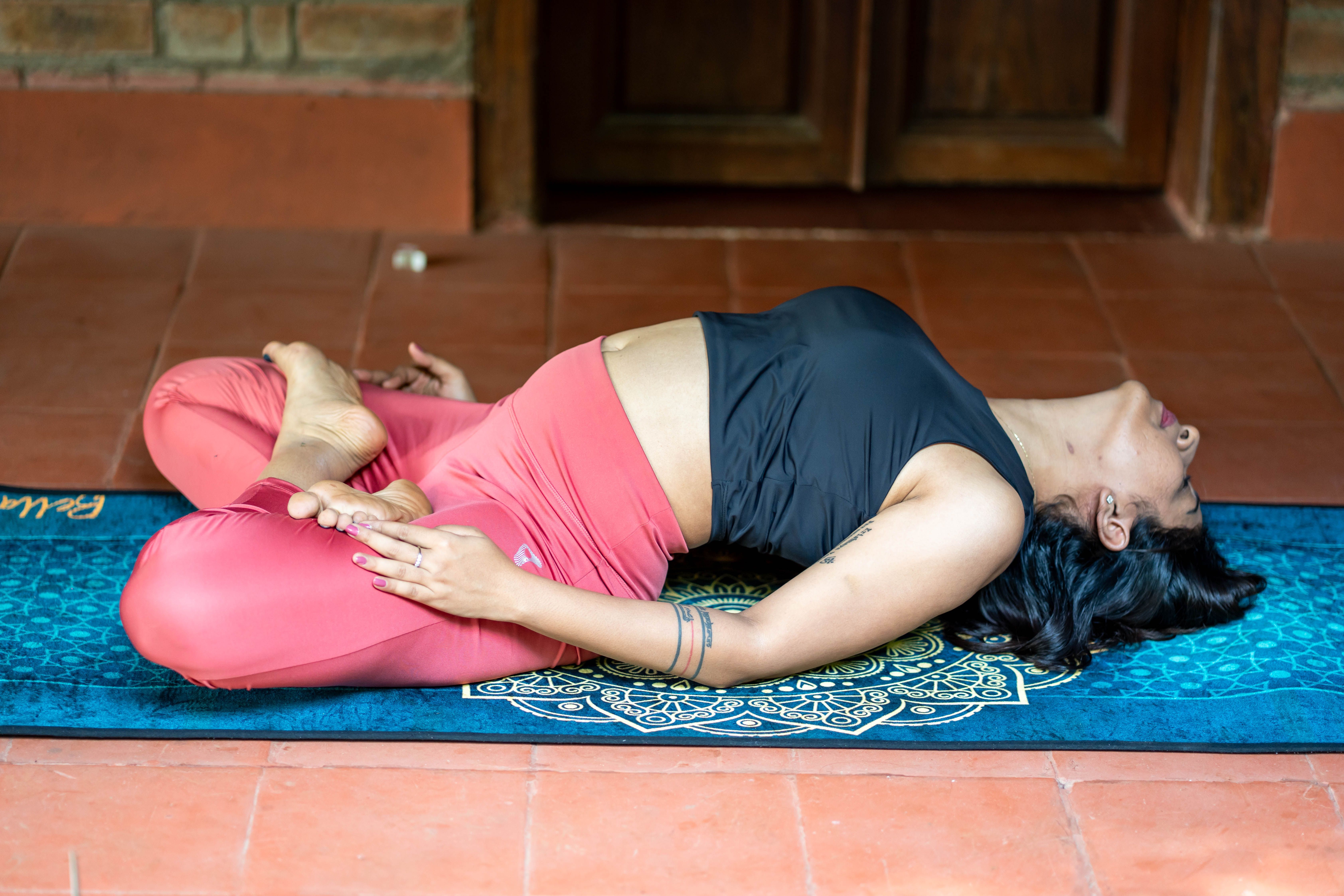 Woman Practicing Yoga Pose Indoors on Mat · Free Stock Photo