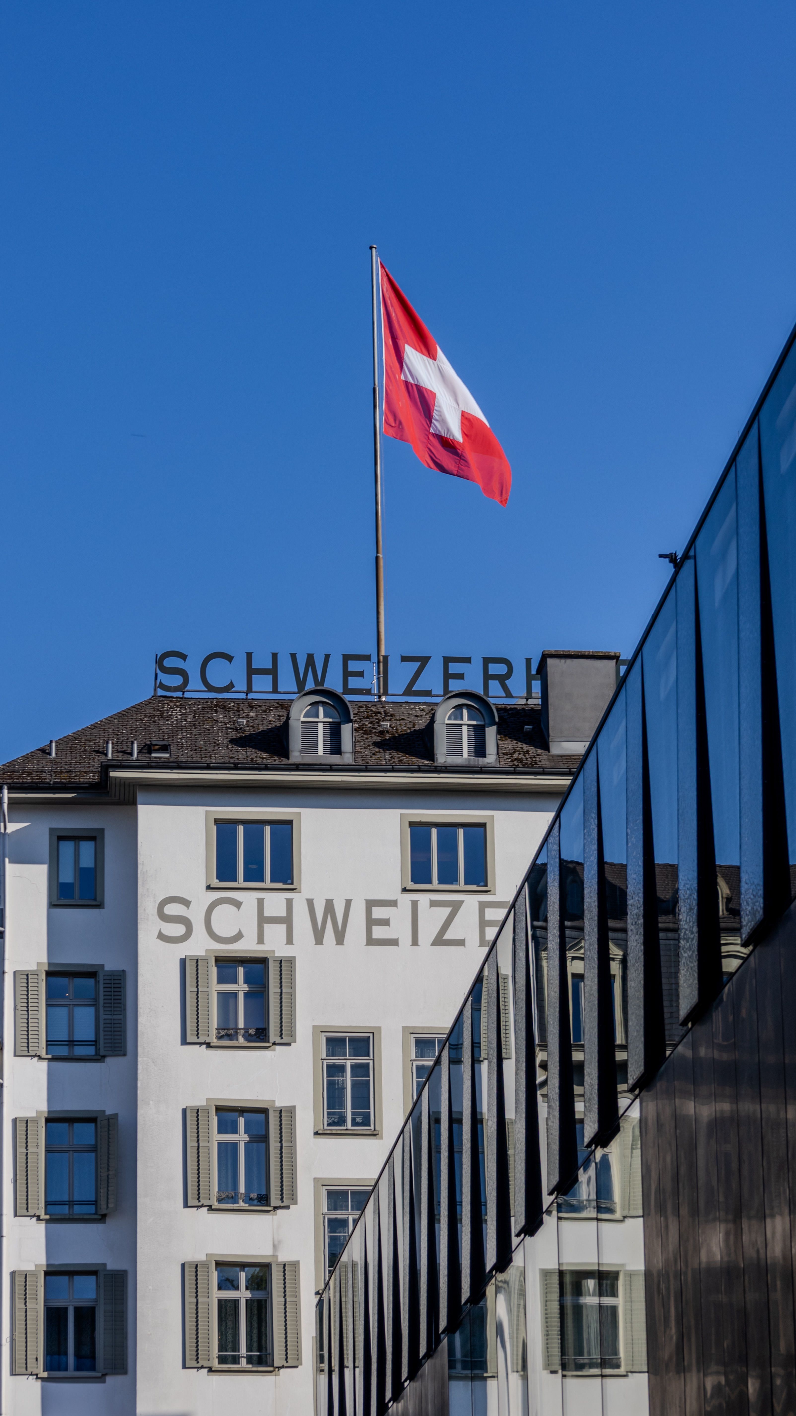 Swiss Architecture with National Flag in Lucerne · Free Stock Photo