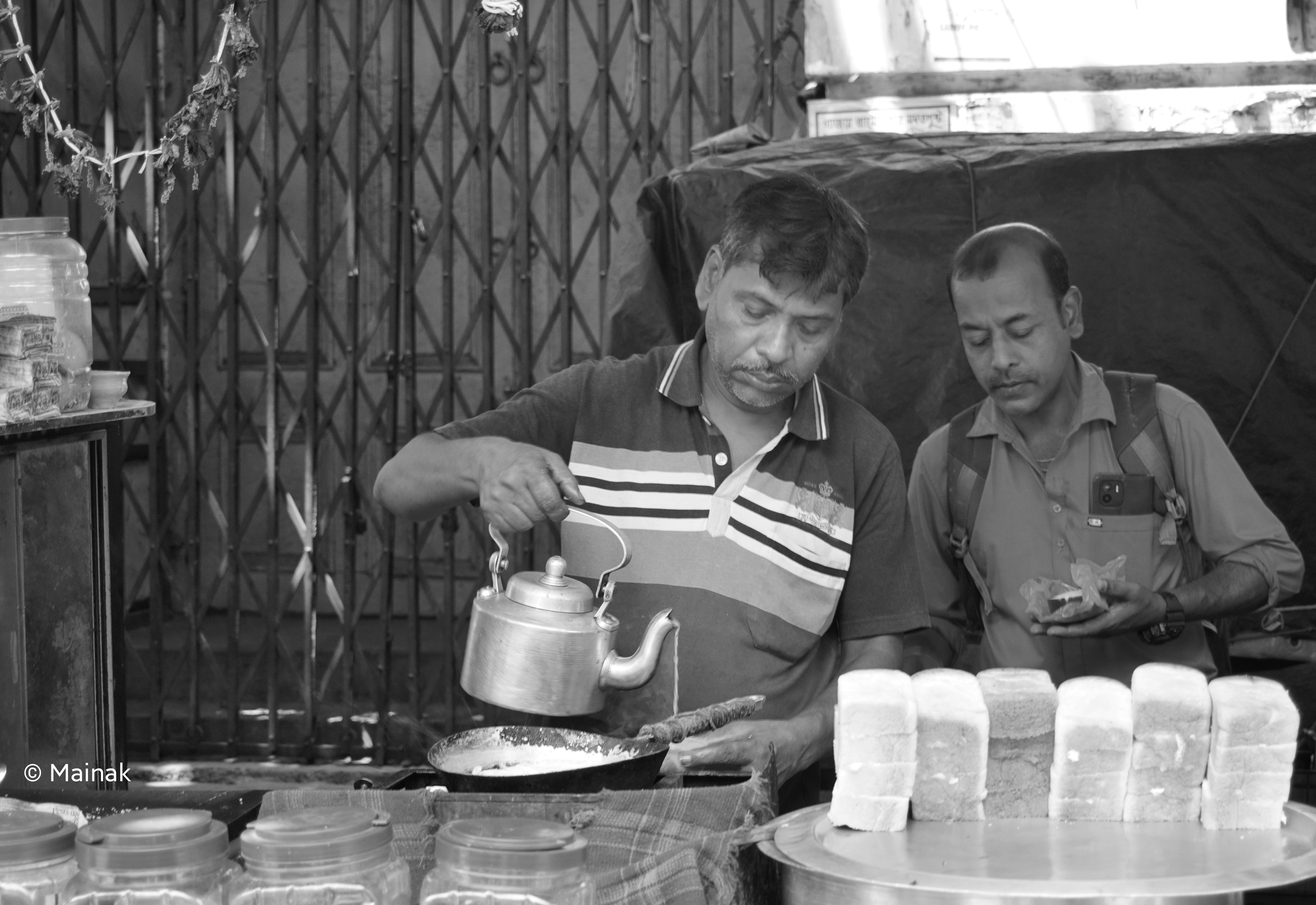 Street Vendor Serving Tea at Outdoor Market · Free Stock Photo