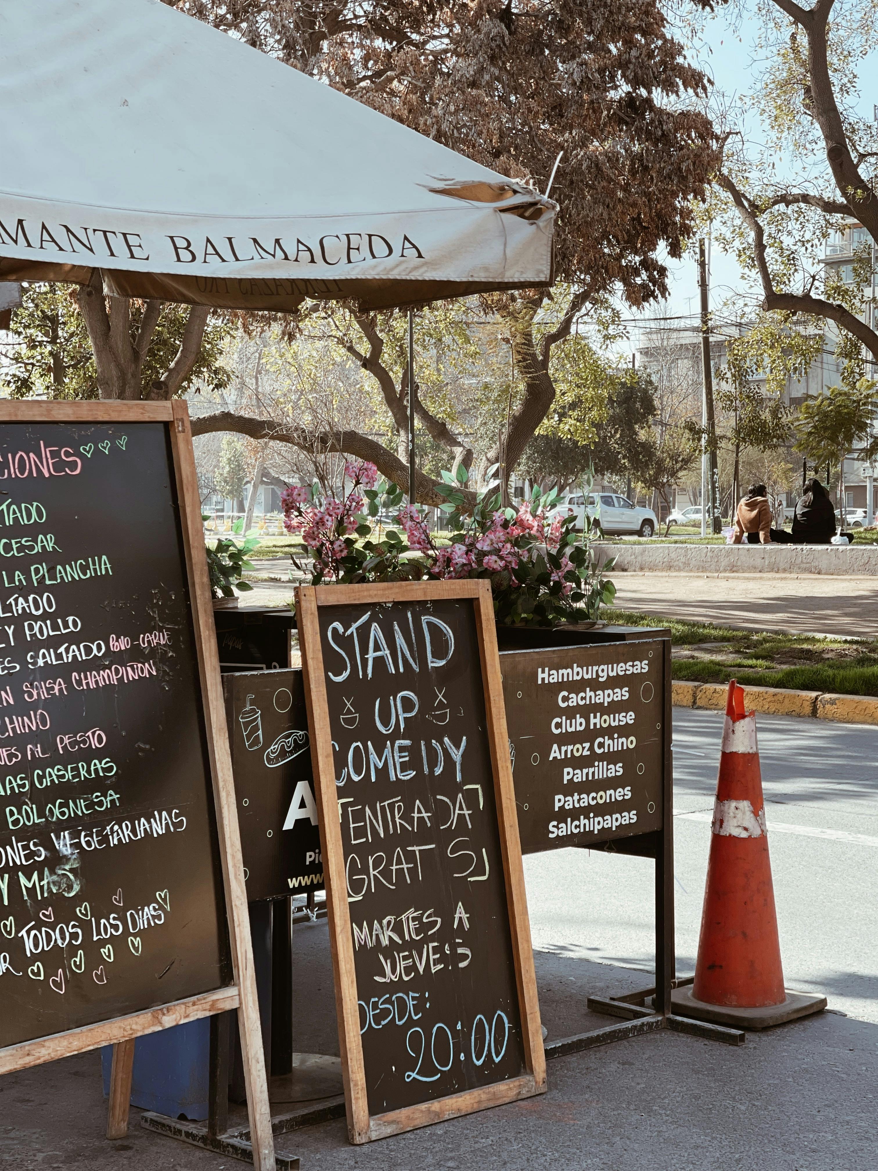 Outdoor Cafe Menu and Comedy Night Signs · Free Stock Photo