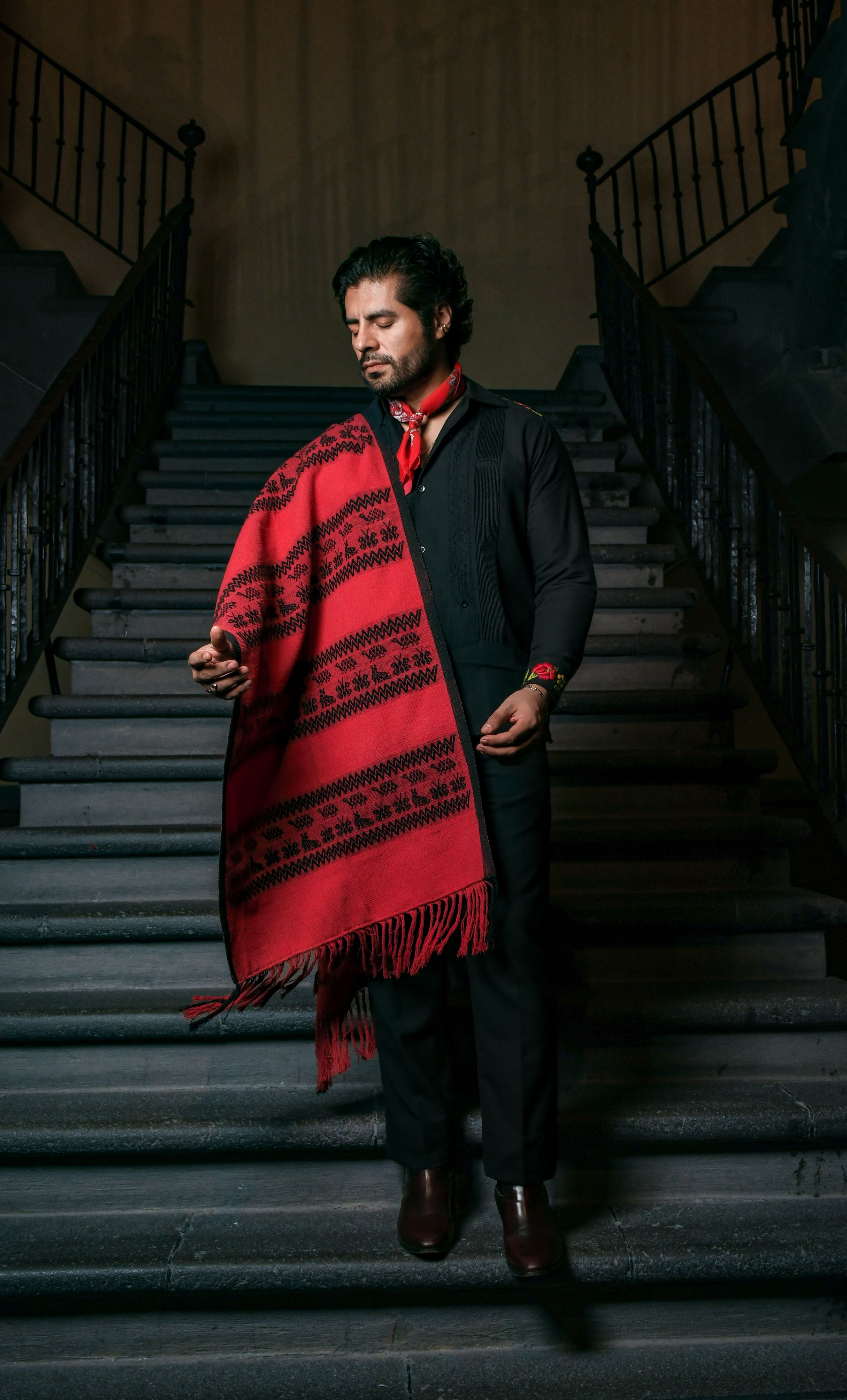Elegant Man in Red Poncho on Dramatic Stairs · Free Stock Photo